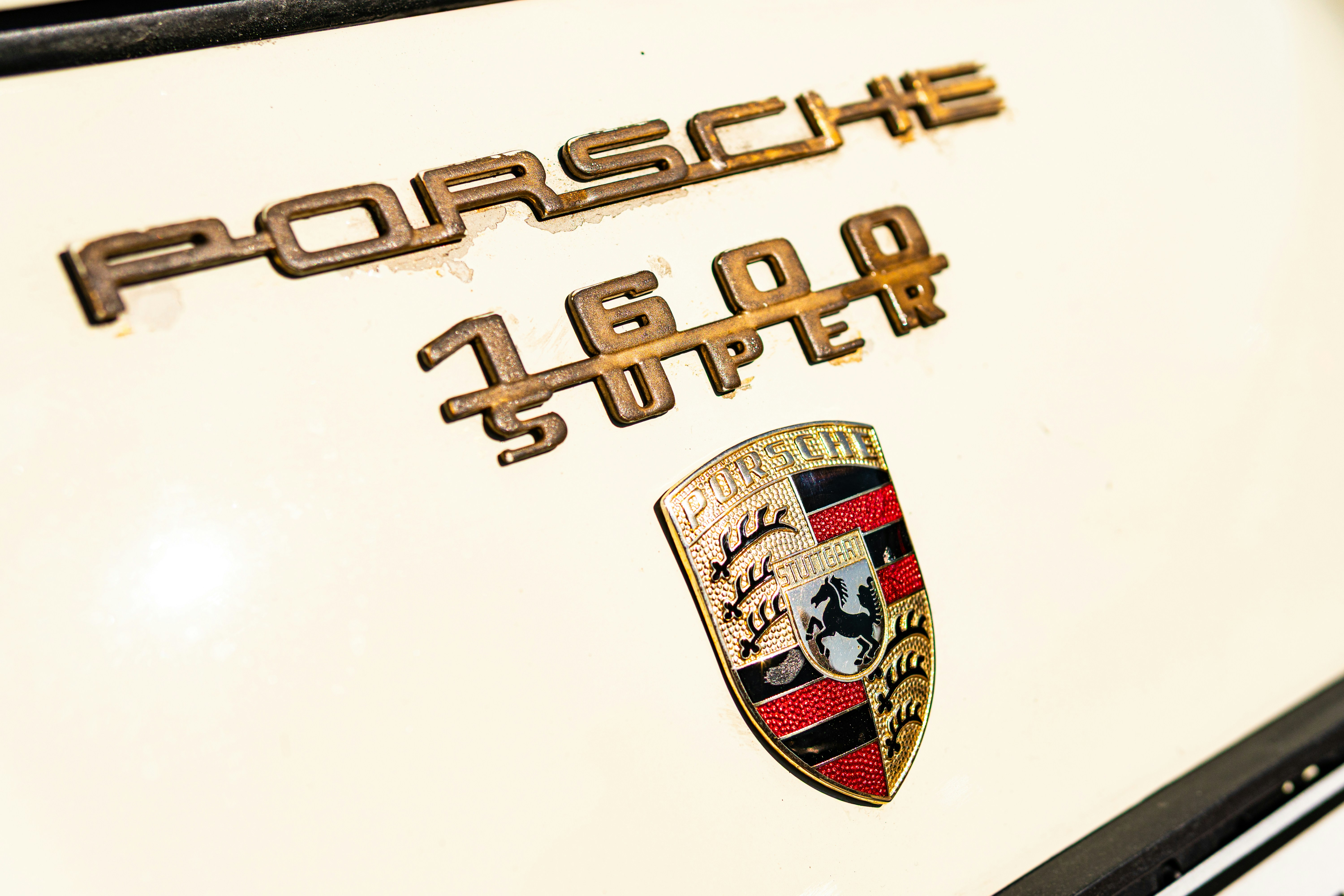 Emblematic Curves: Porsche Crest on a Creamy Canvas
