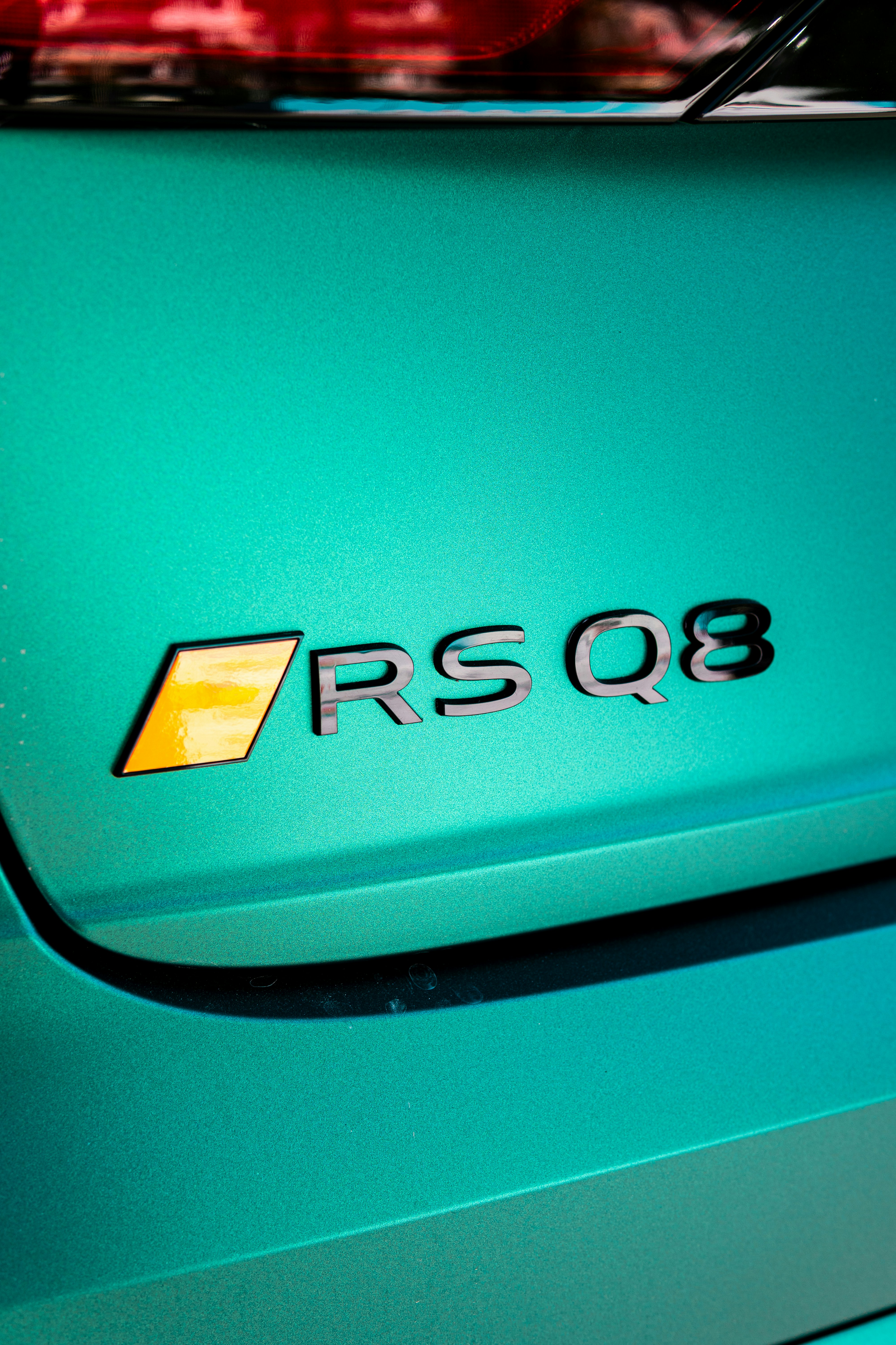 Teal RSQ8 Emblem on a Teal Metallic Panel