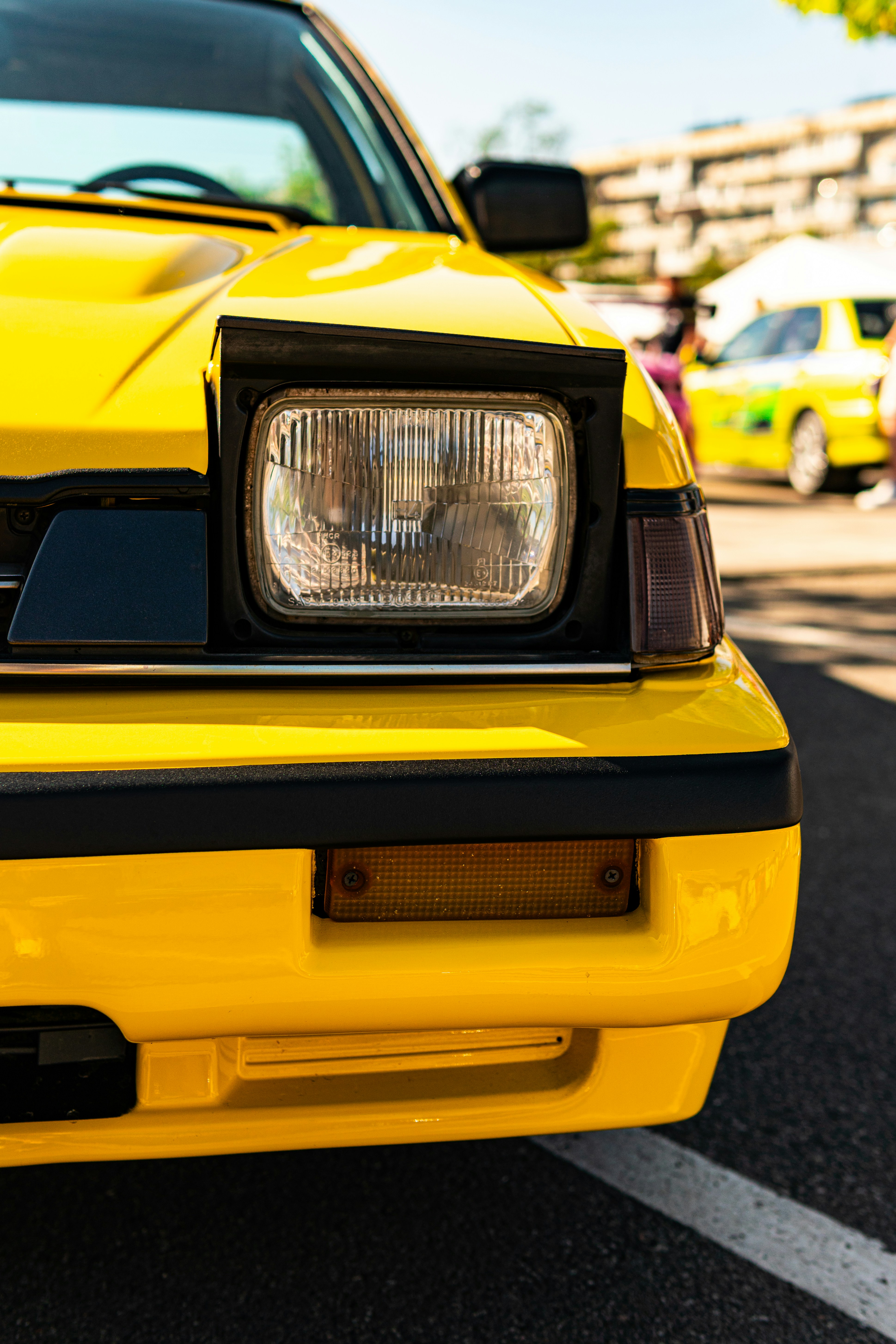 Front-Quarter of a Bright Yellow Taxi, Headlight as Centerpiece