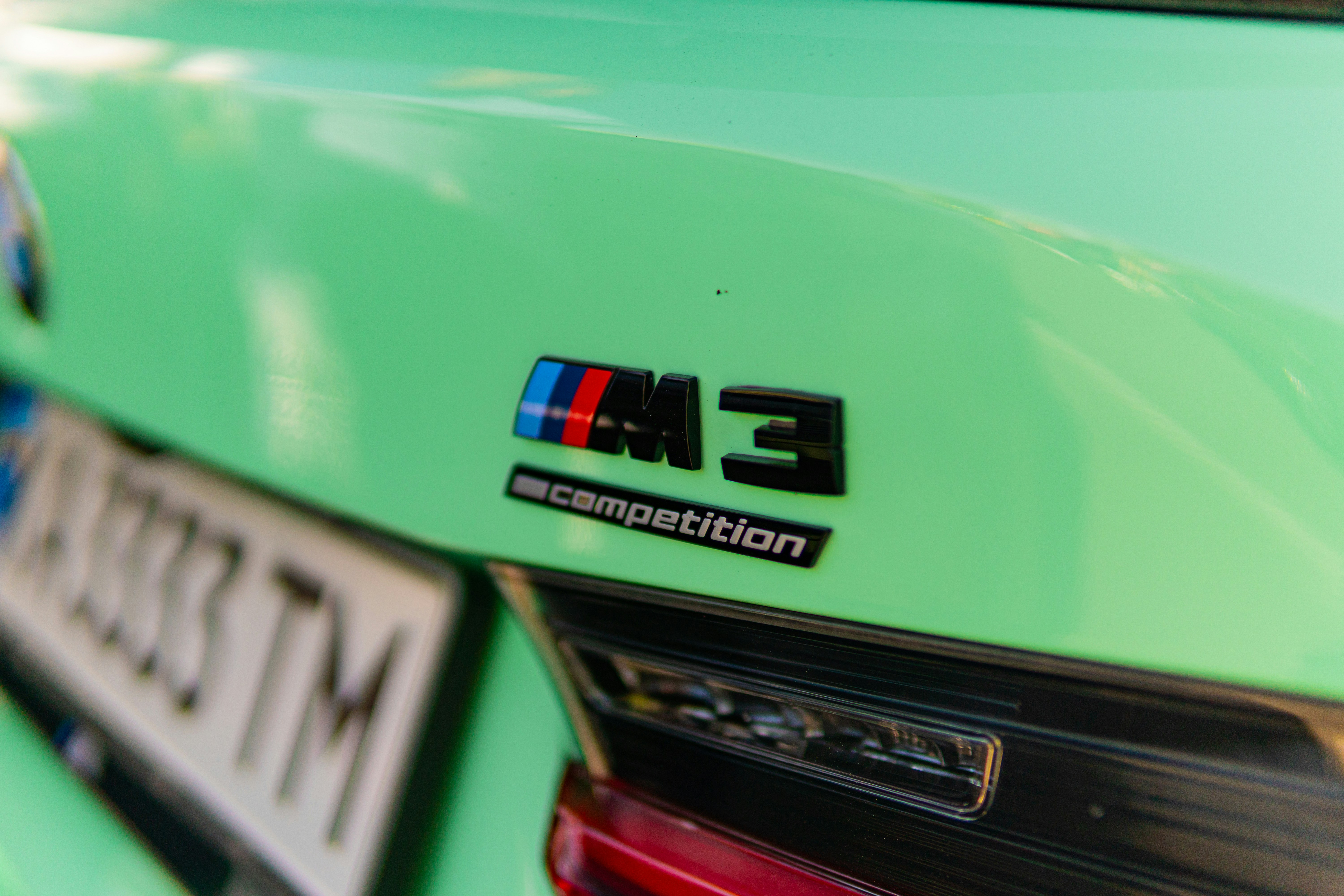 M Power: Mint Green BMW M3 badge on a vintage green rear