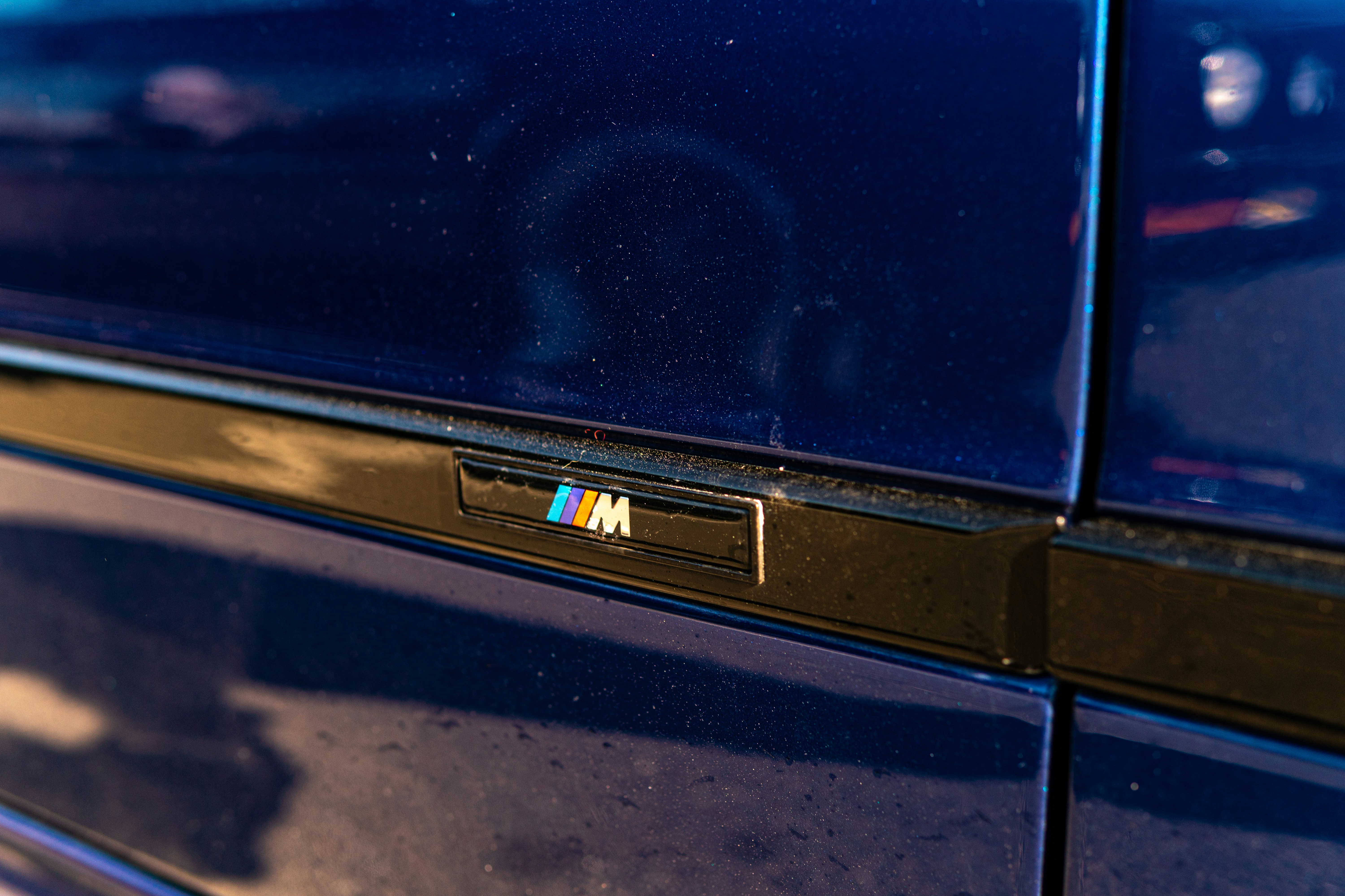 M Badge on Metallic Blue SUV’s Trim