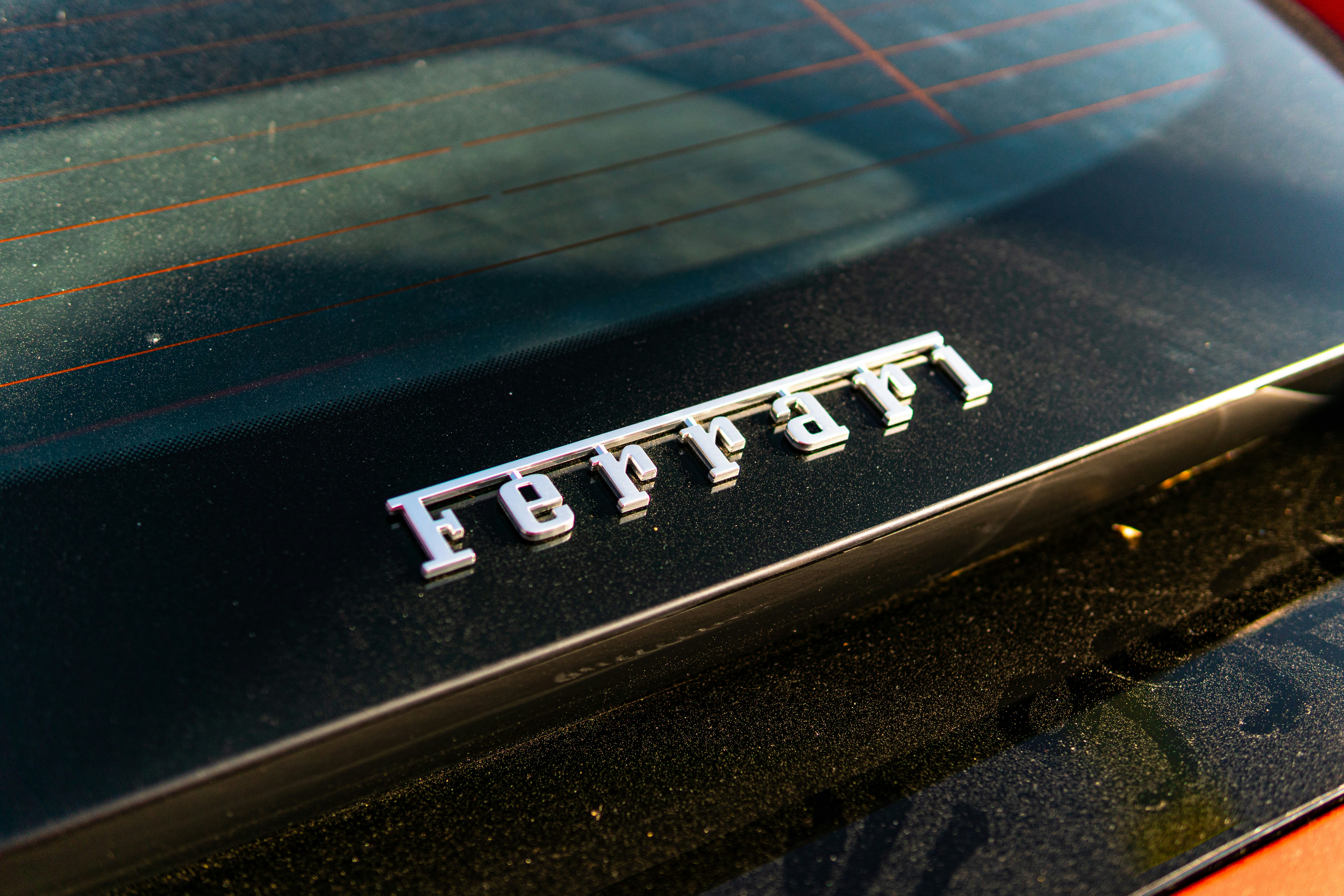 Chrome Script: Ferrari Badge on Dirt-Streaked Trunk
