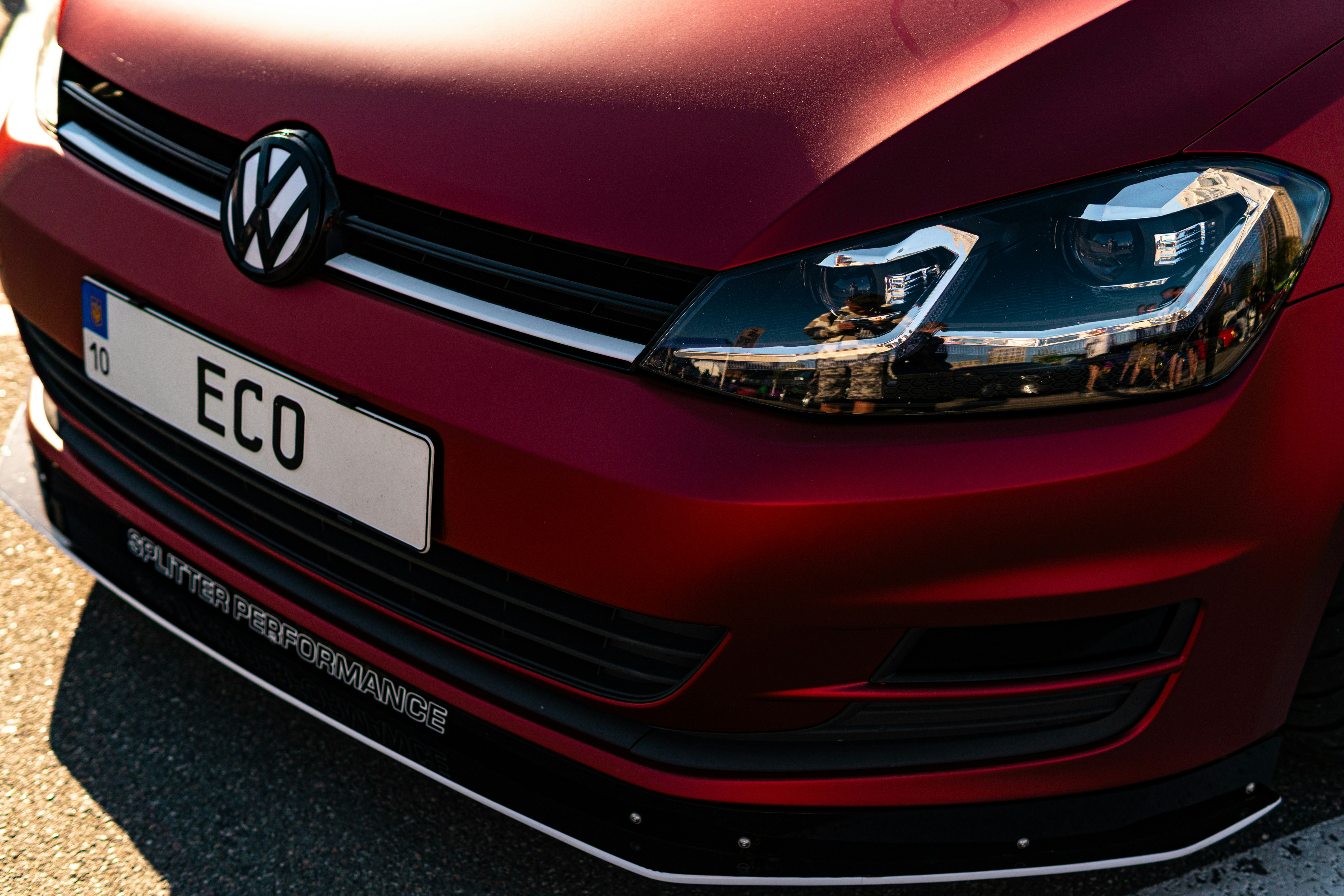 Red Volkswagen in Close-Up: A Sharp, Sunlit Front End