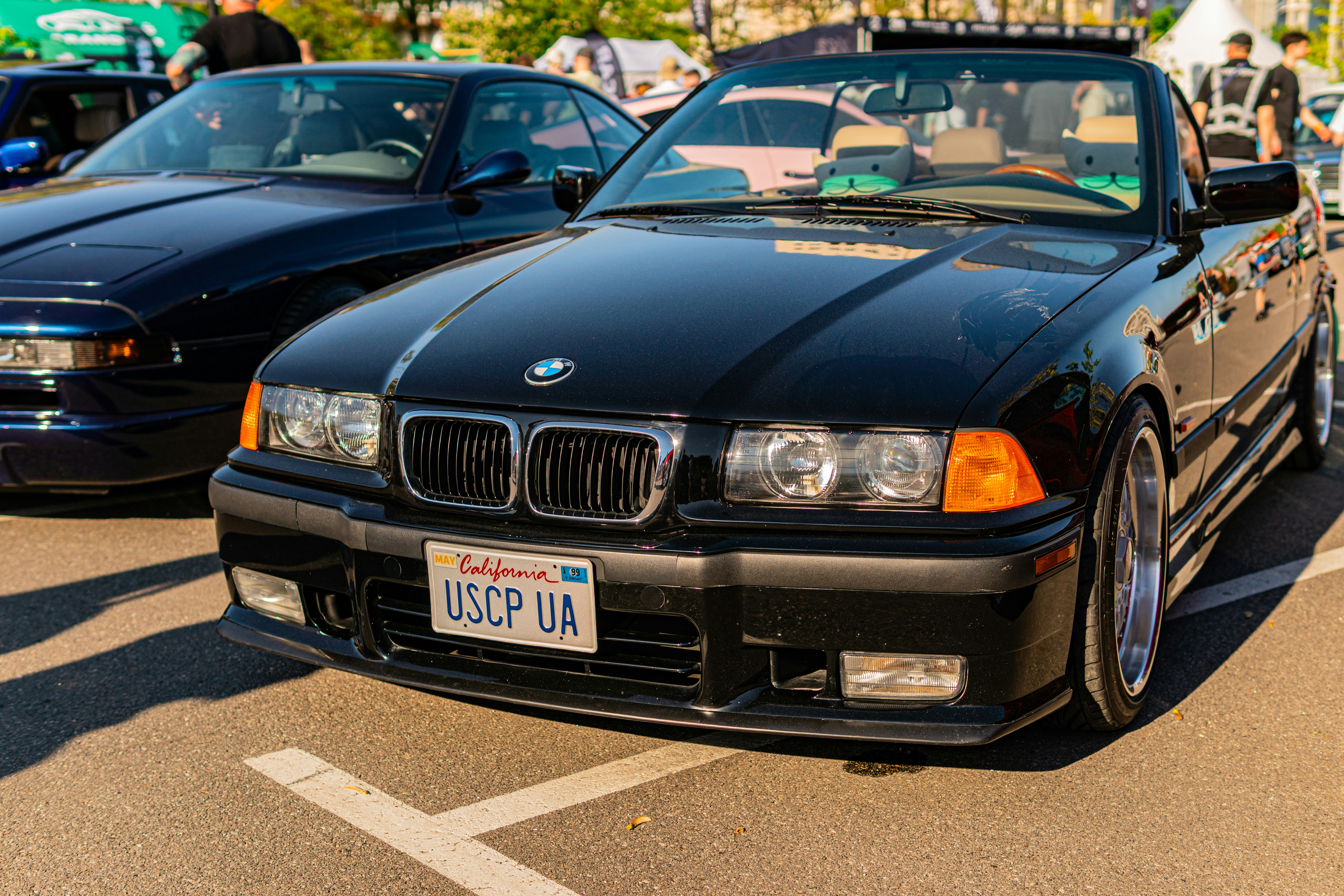 Blue BMW in a Sunlit Parking Lot: Detail and Depth