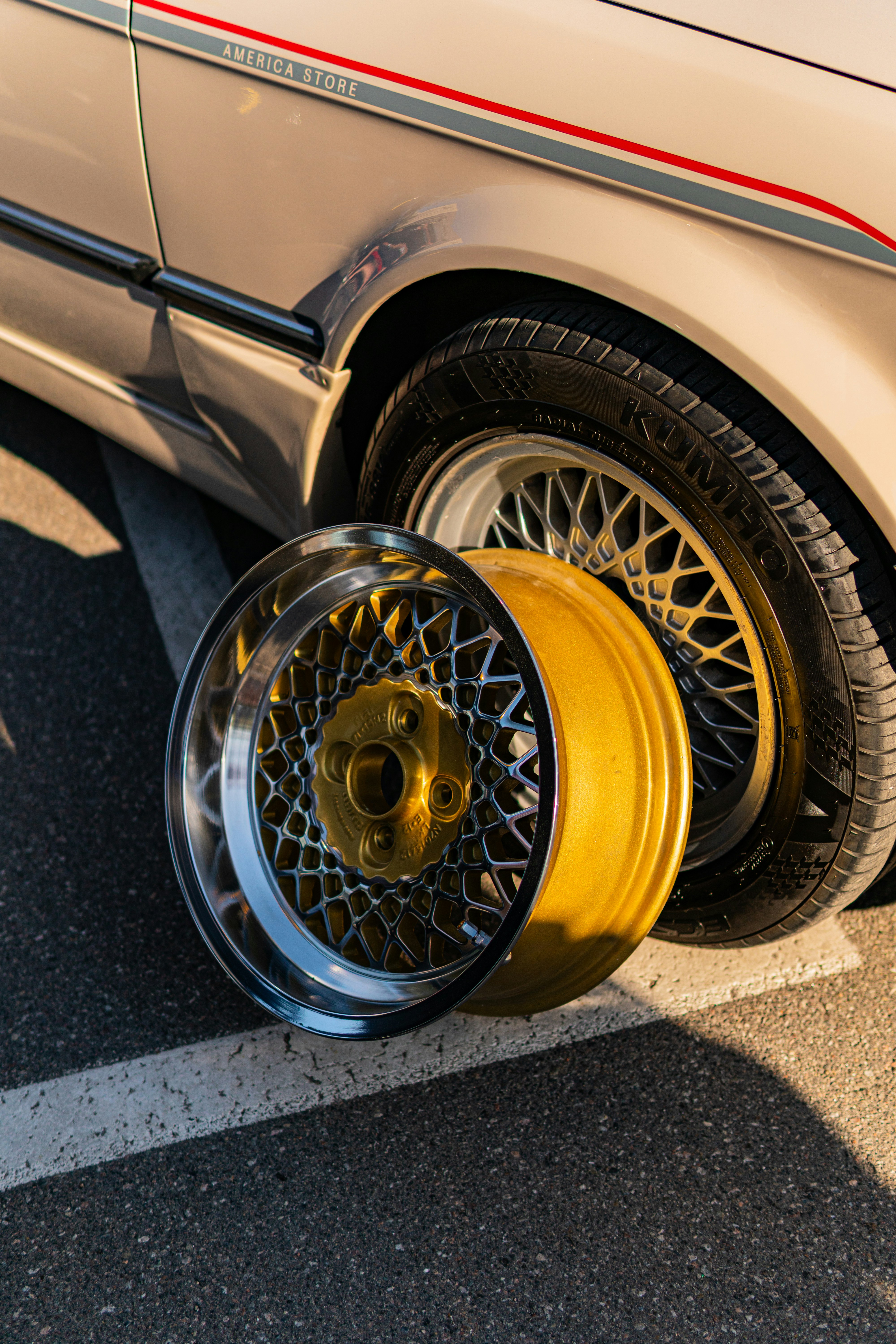 Chipped Car Tire and Disassembled Wheel in Parking Lot