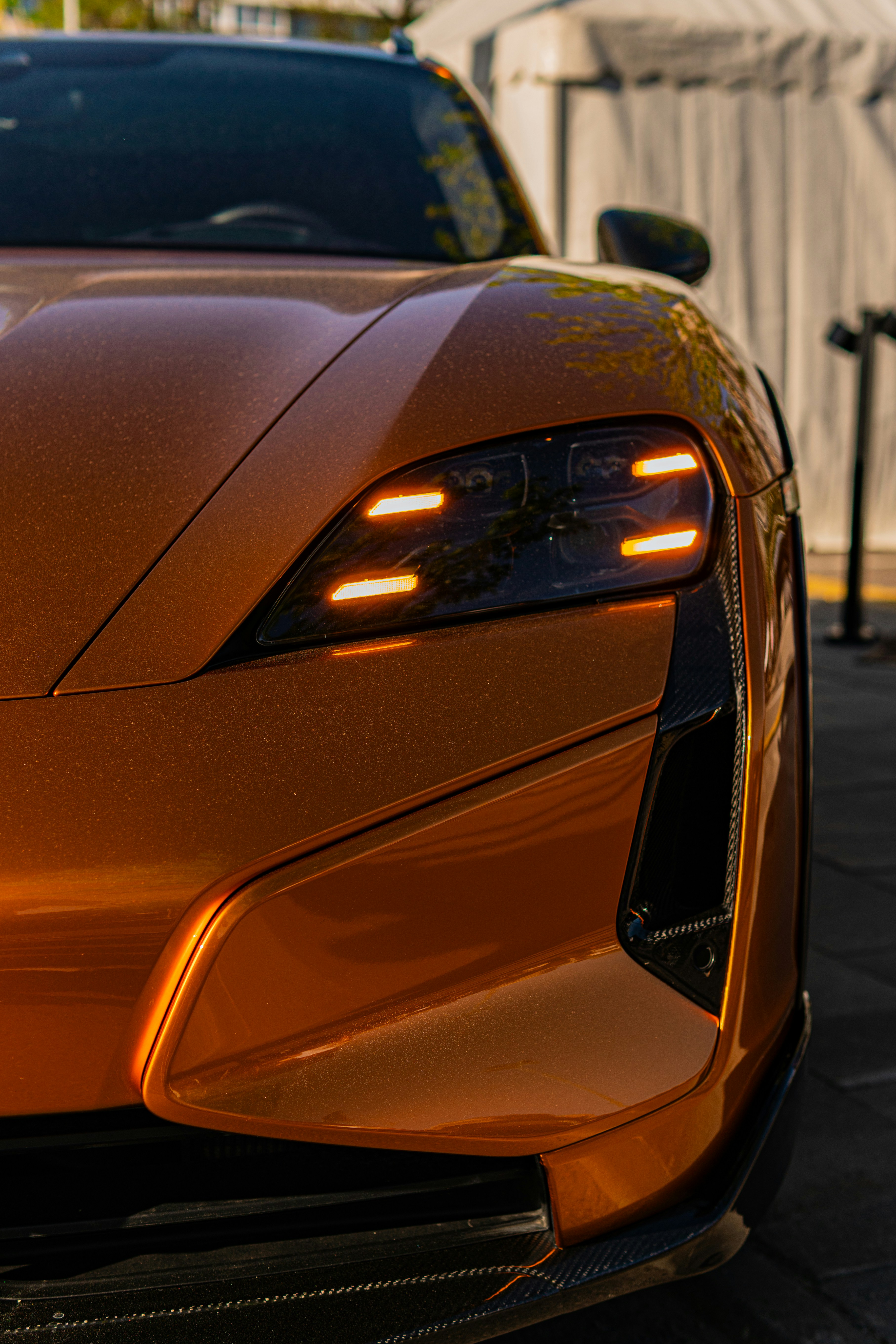 Amber velocity: close-up of a gold McLaren’s illuminated front end