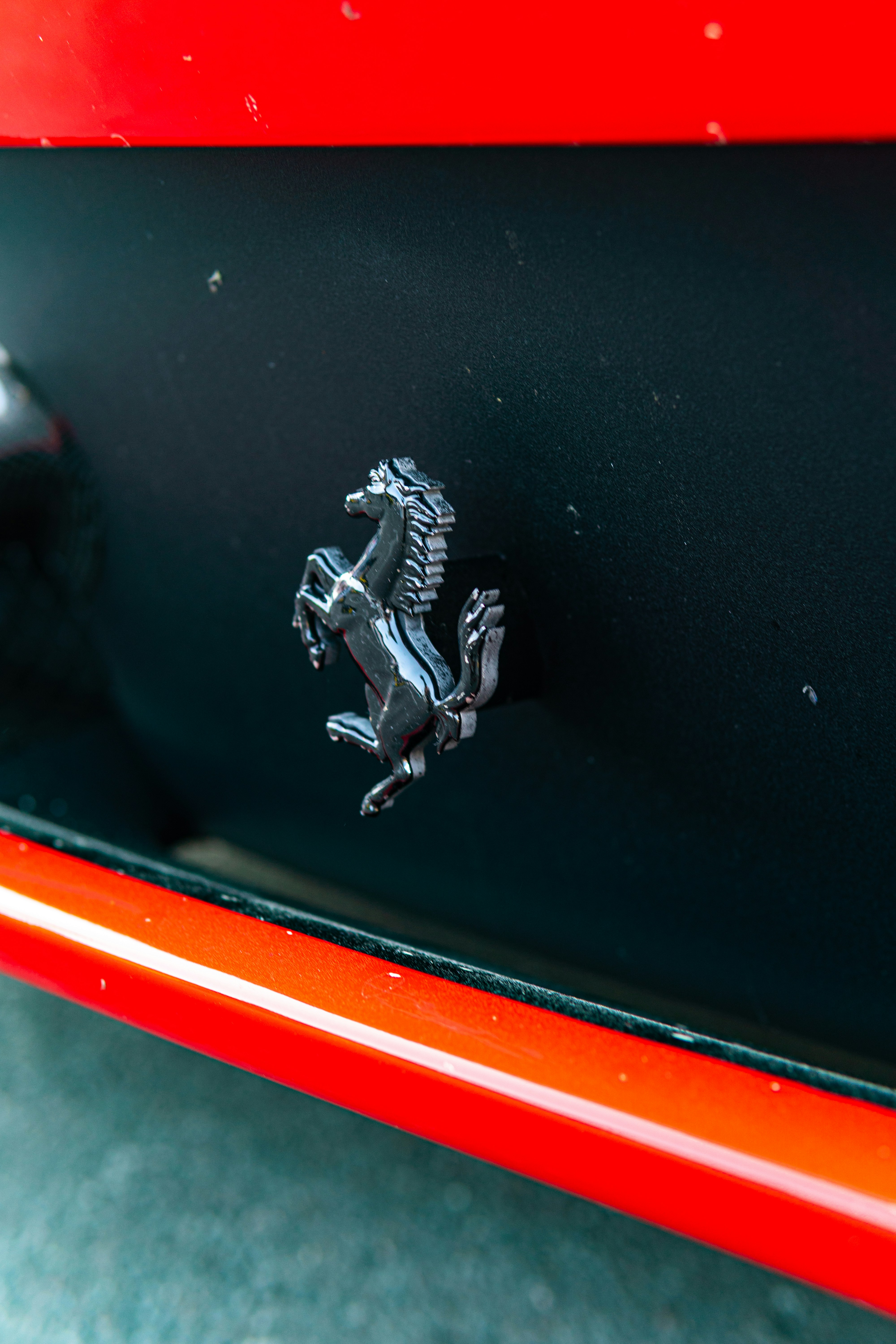 Ferrari Emblem Lights Up a Red Car’s Quiet Corner