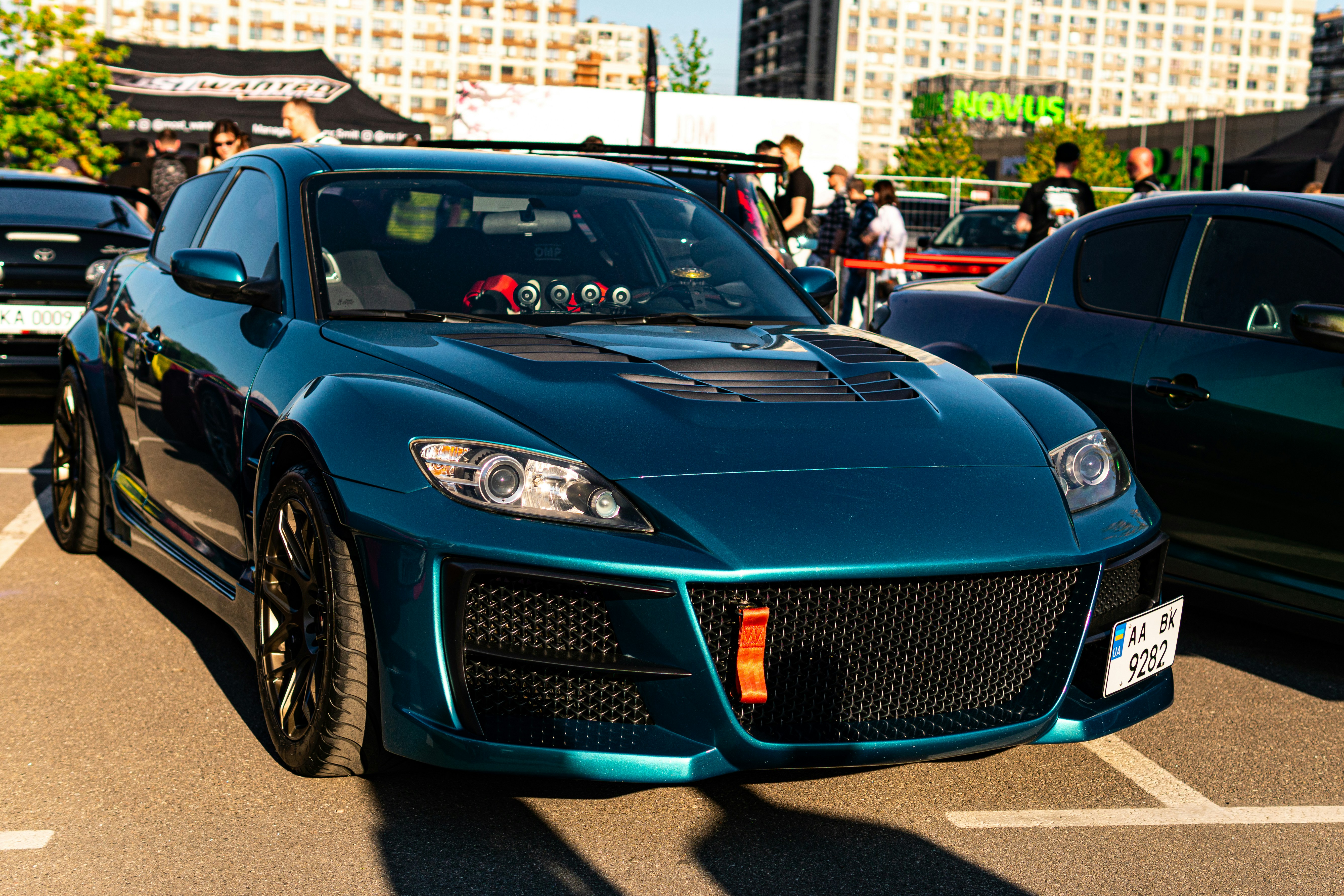 Midday Blues: A Sharp Blue Sports Car at a Car Meet