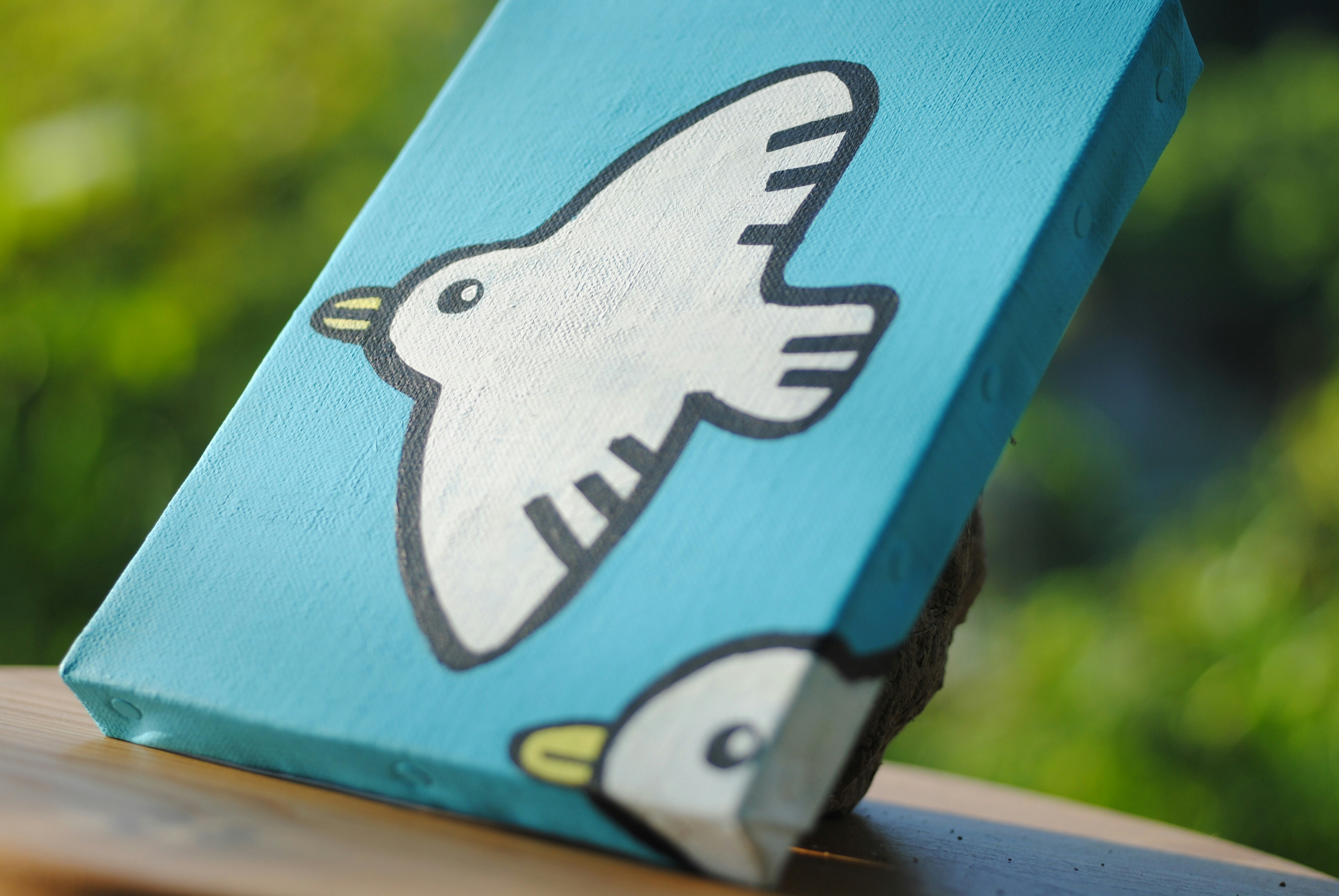Blue Block with Flying Dove: A Painted Moment on a Tilted Plaque