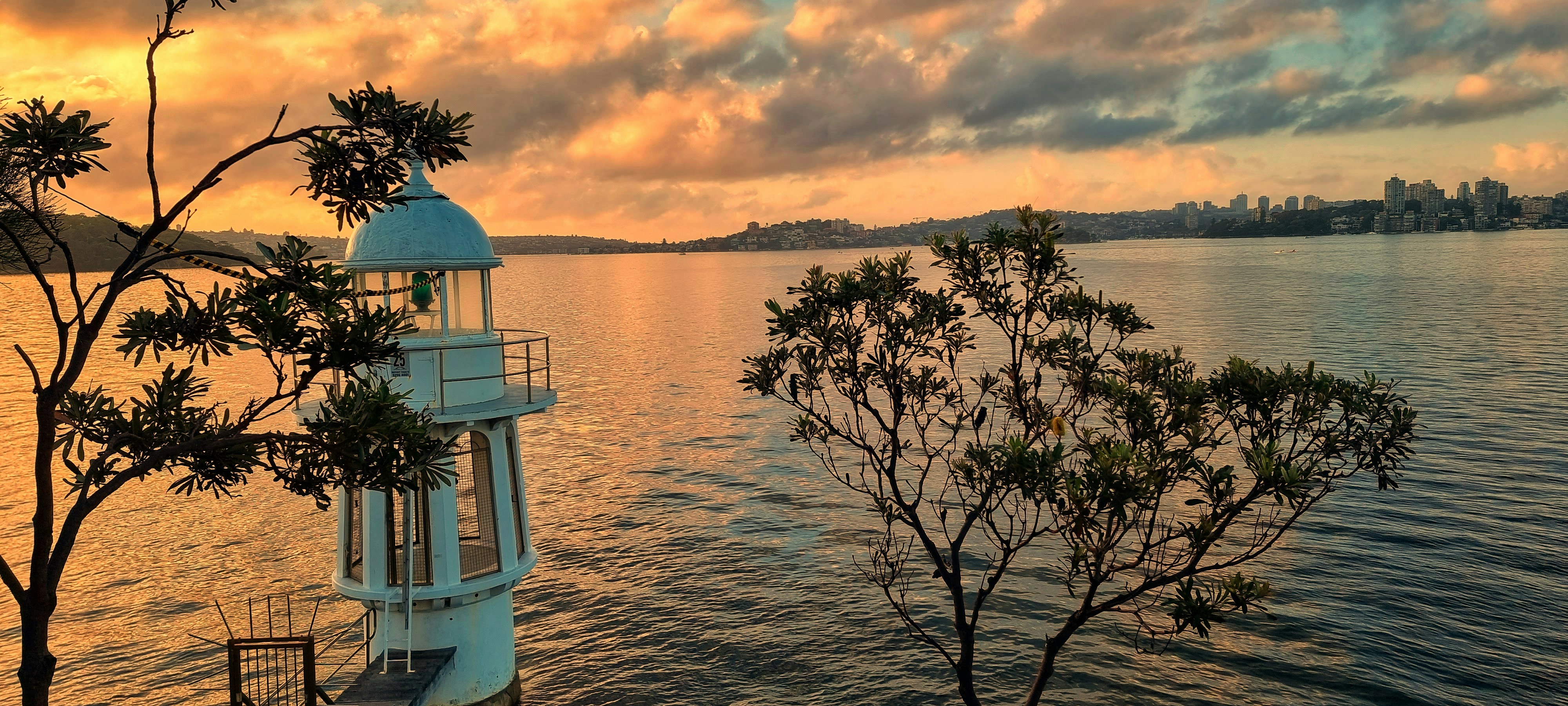 Sunset Beacon Over Calm Waters