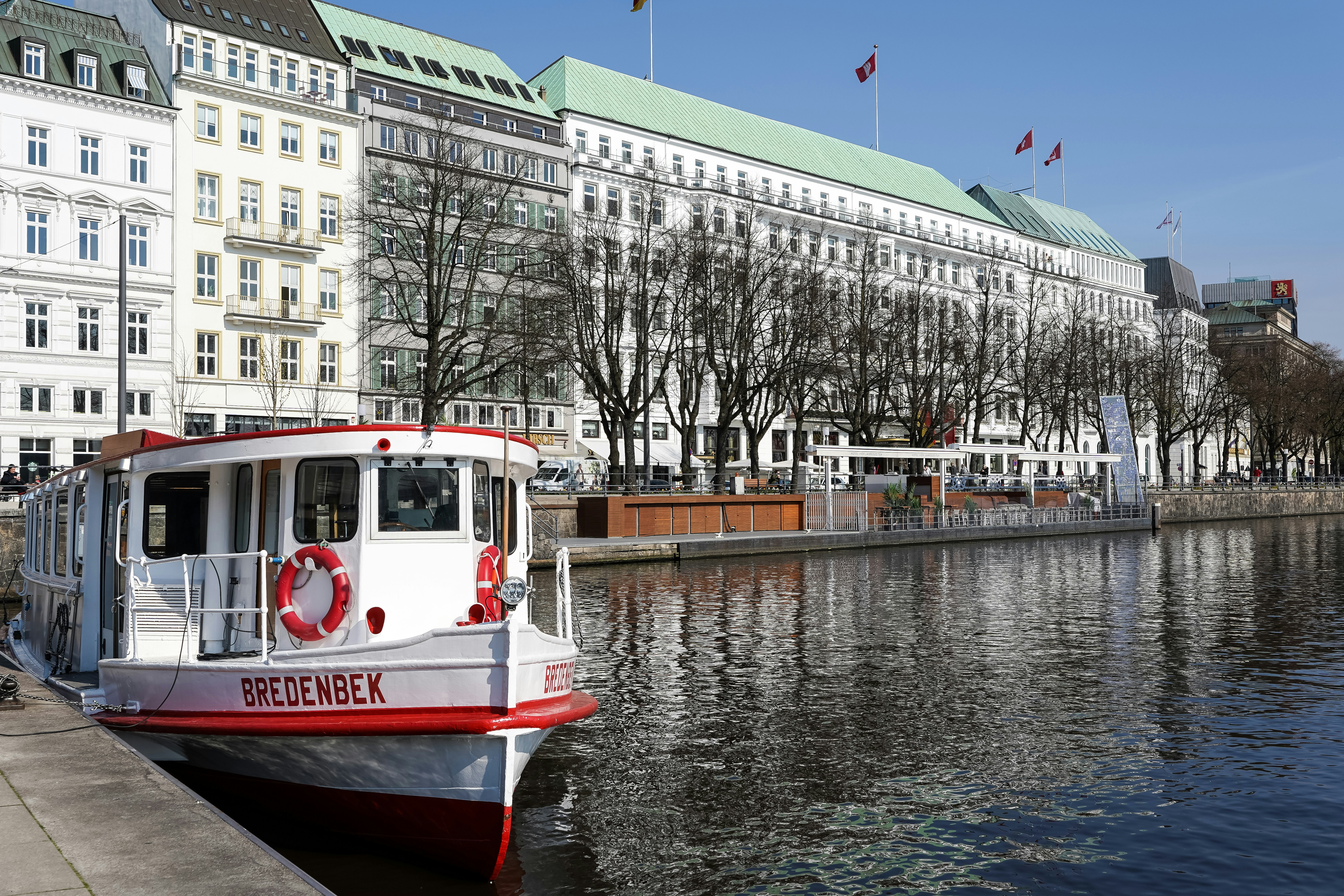Harbor Boat at Bremmen Riverfront: Calm Water and Historic Facades