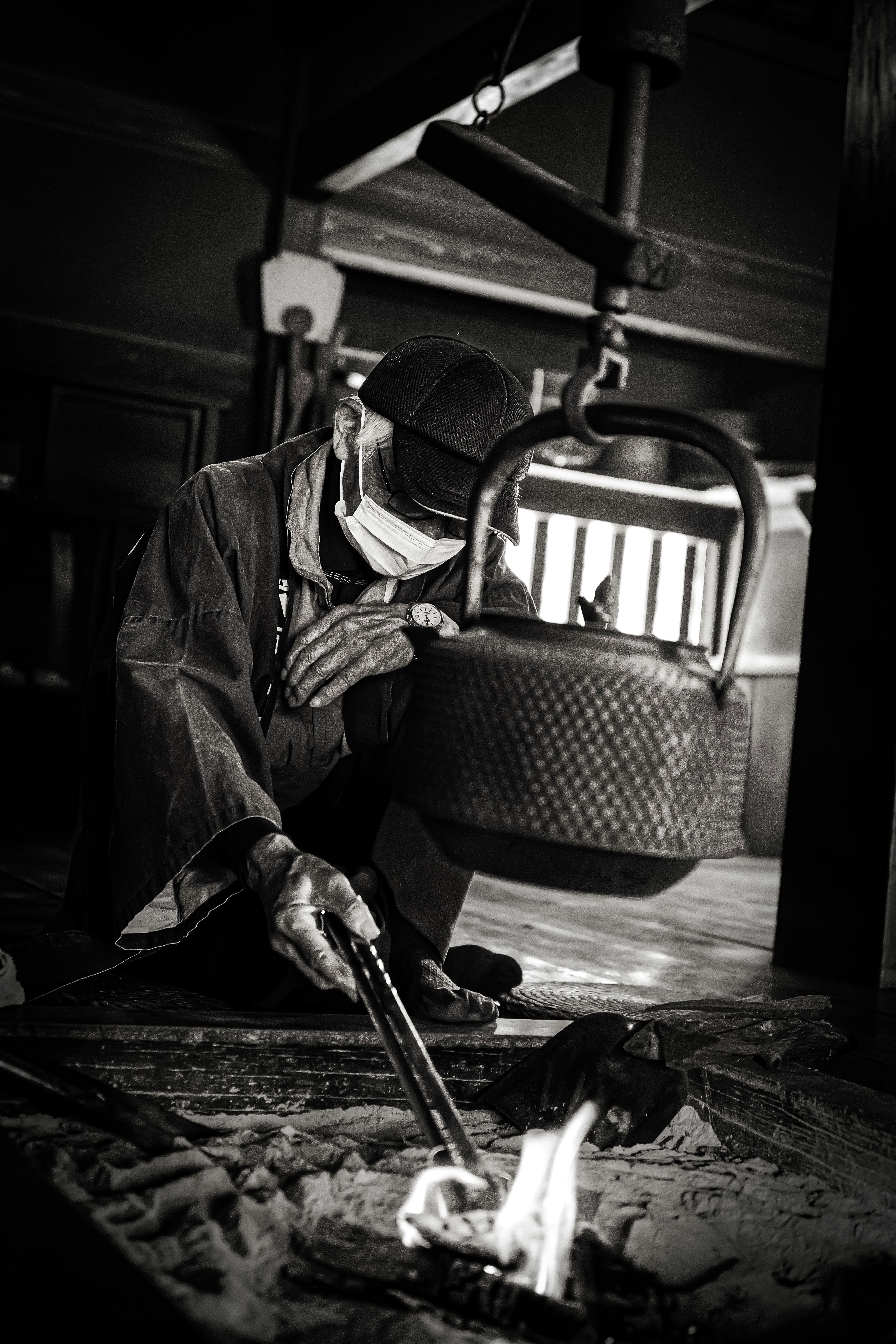 Masked Worker by the Hearth: Remnant of Hands and Heat