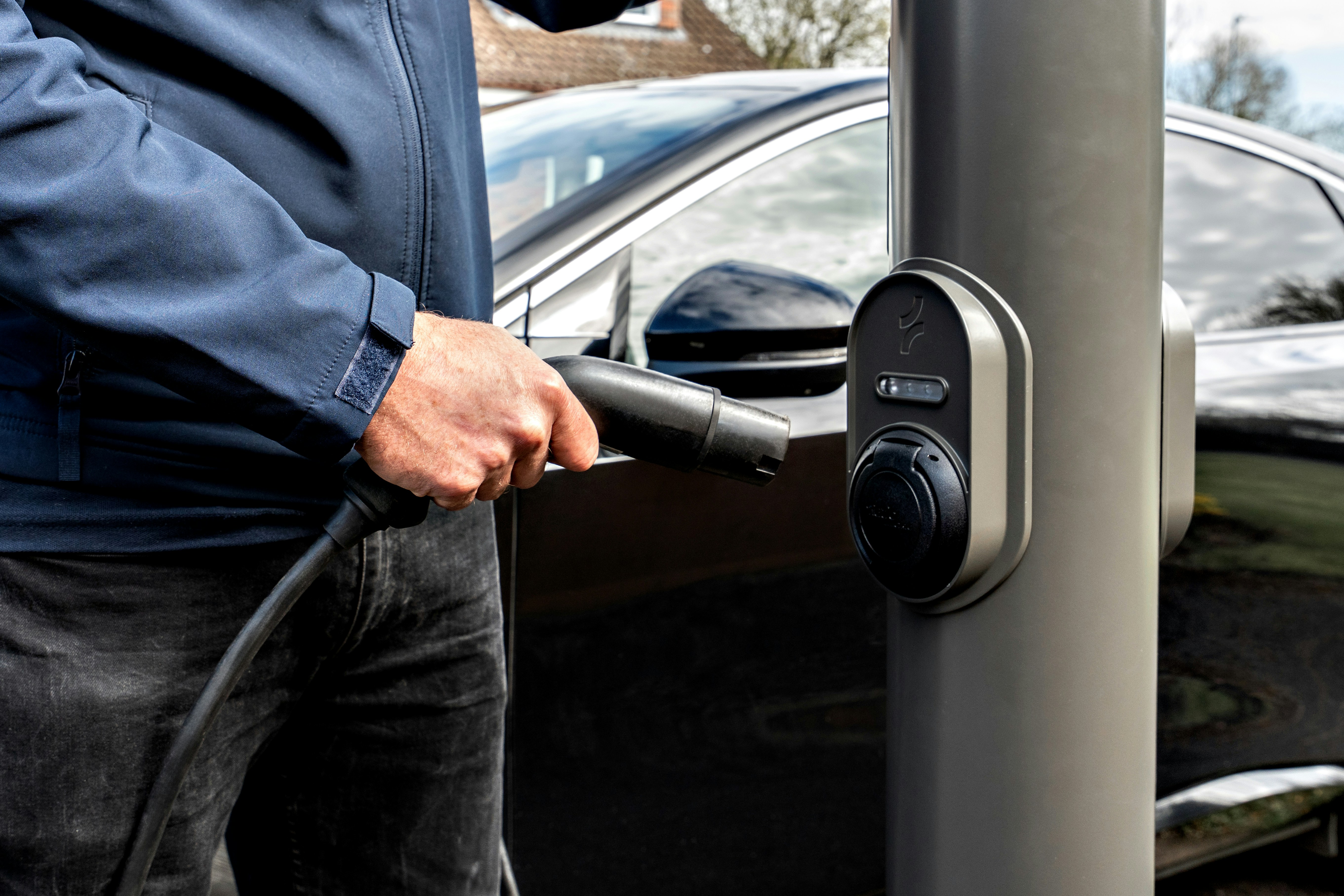 Charging Moment: Hands Grip and Cable Meet Power