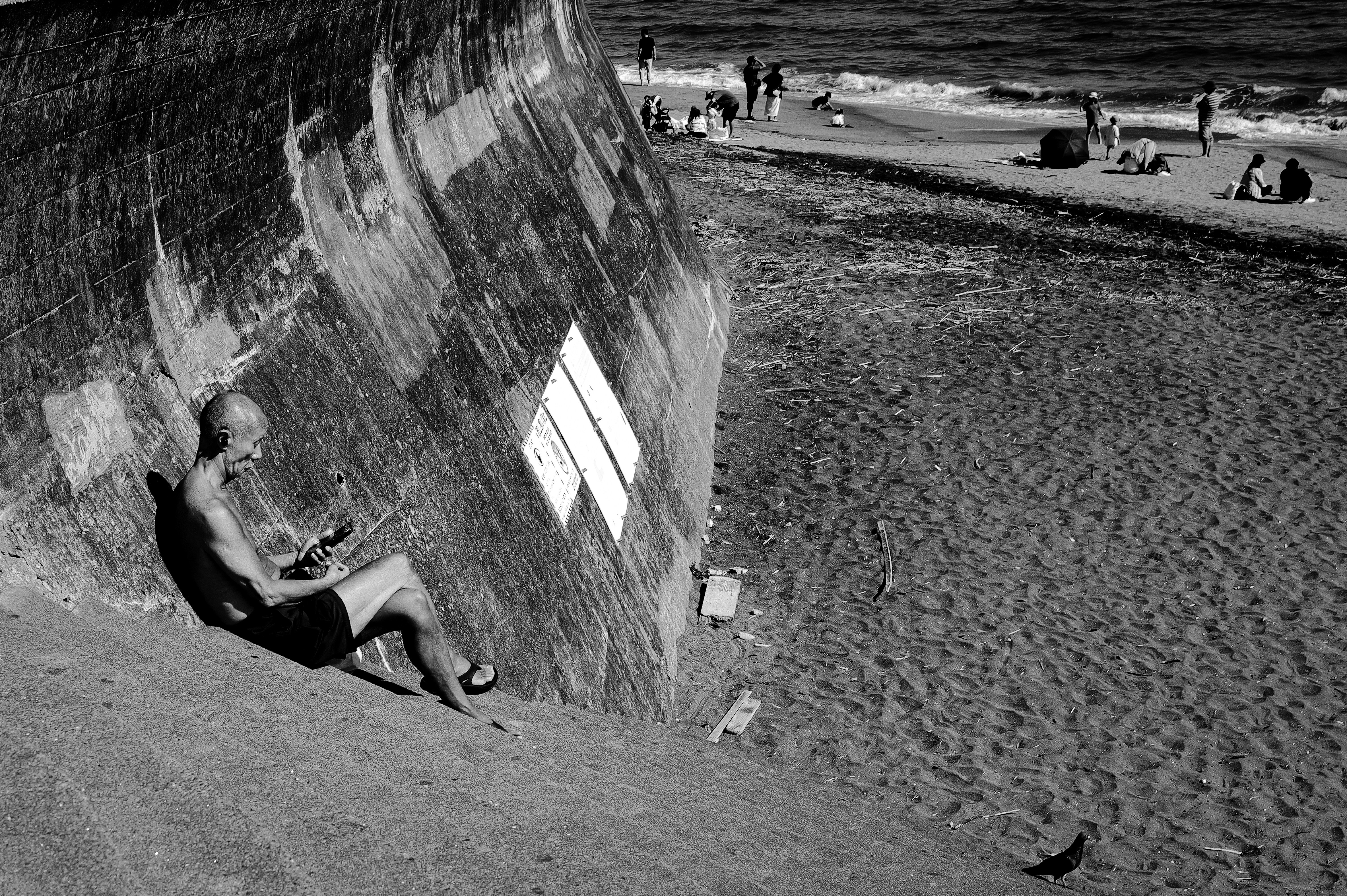 Solitary Seaside Recline by the Shadowed Wall
