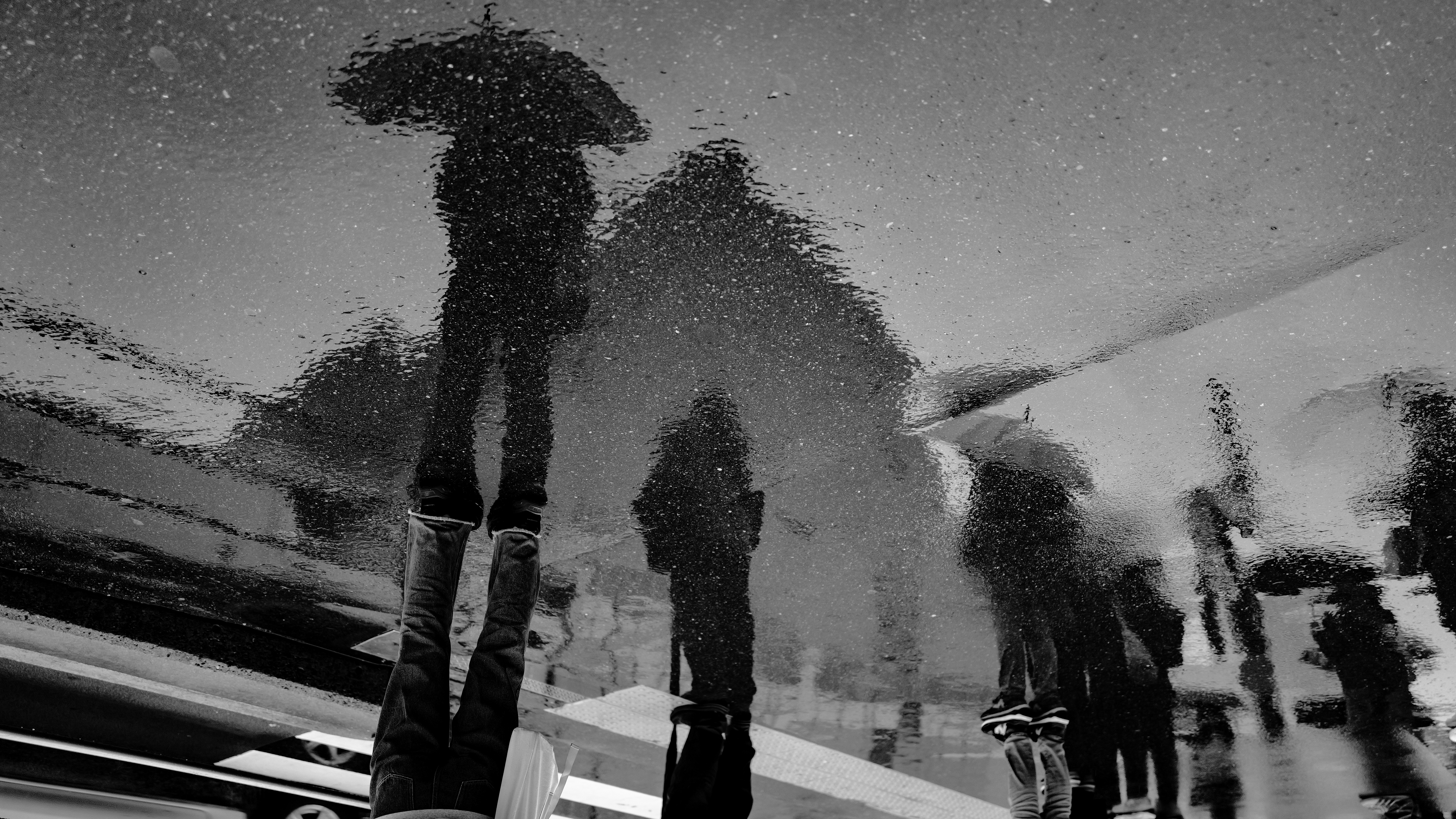 Urban Echoes: Reflections of Silhouettes on Wet Glass