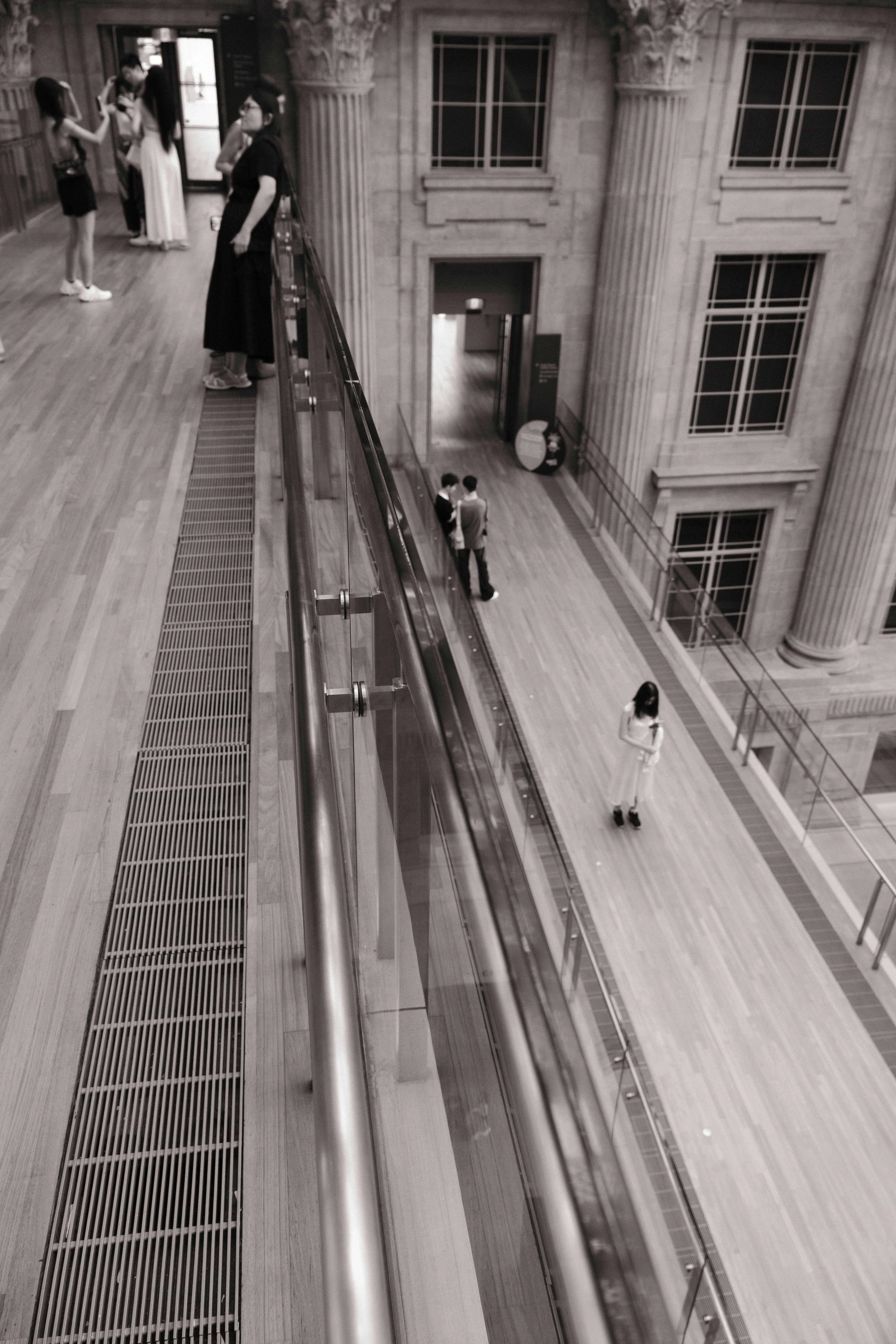 Elevatorview Echoes: Quiet Figures Along a Grand Atrium