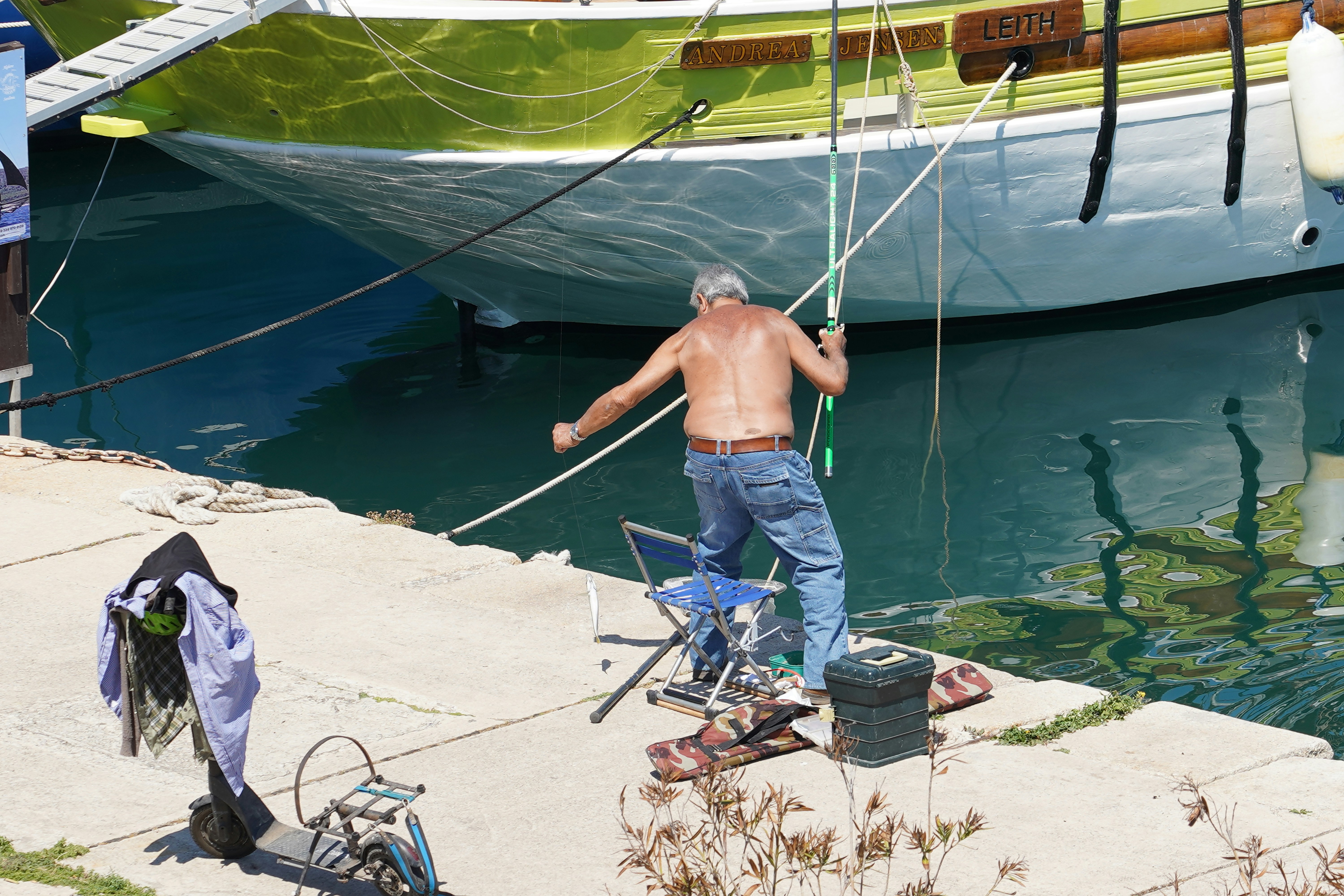 Dockside Net Mender in Focused Pause