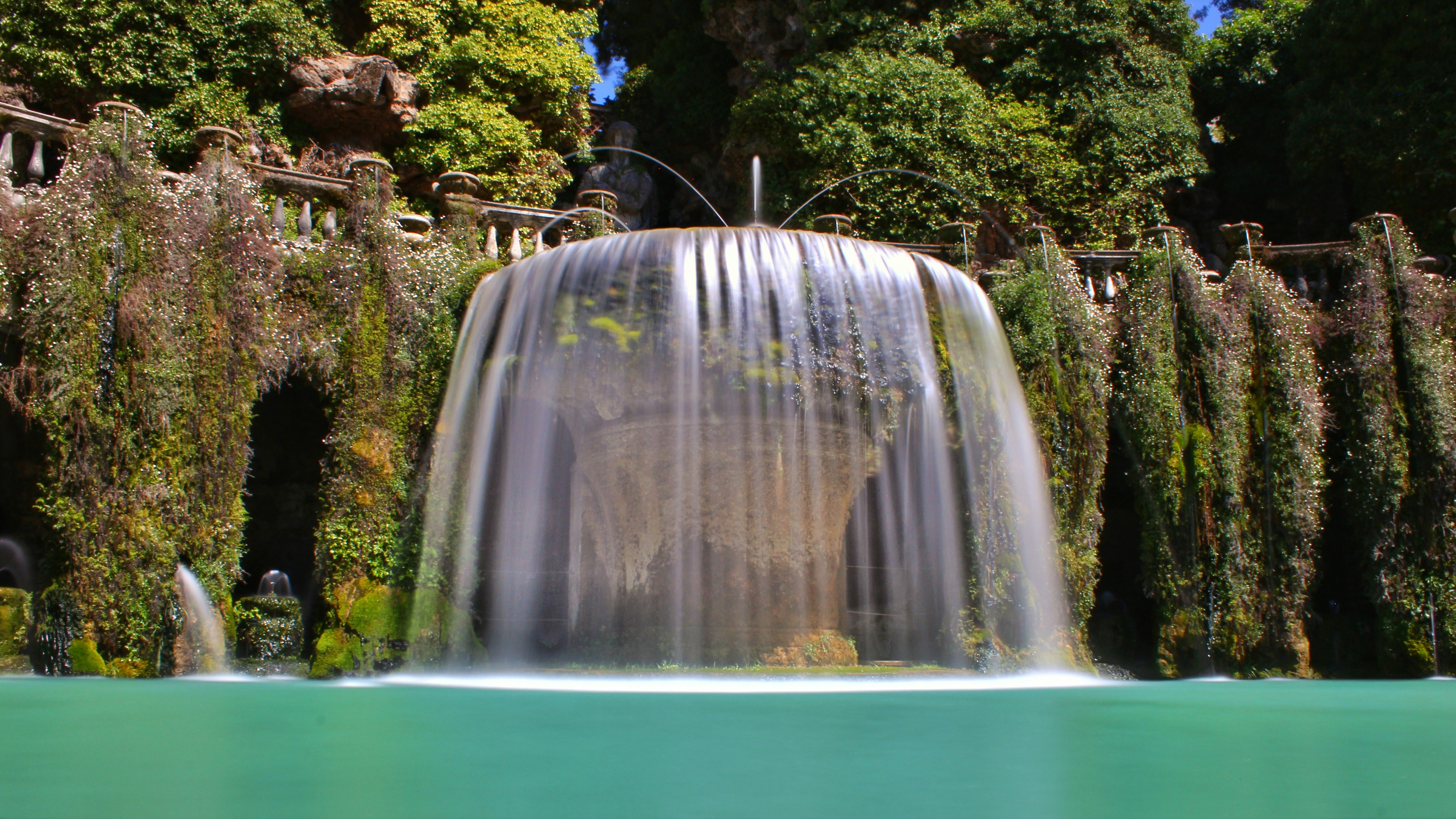 Cascade Crown: A Turquoise Pool Framed by Verdant Terrace
