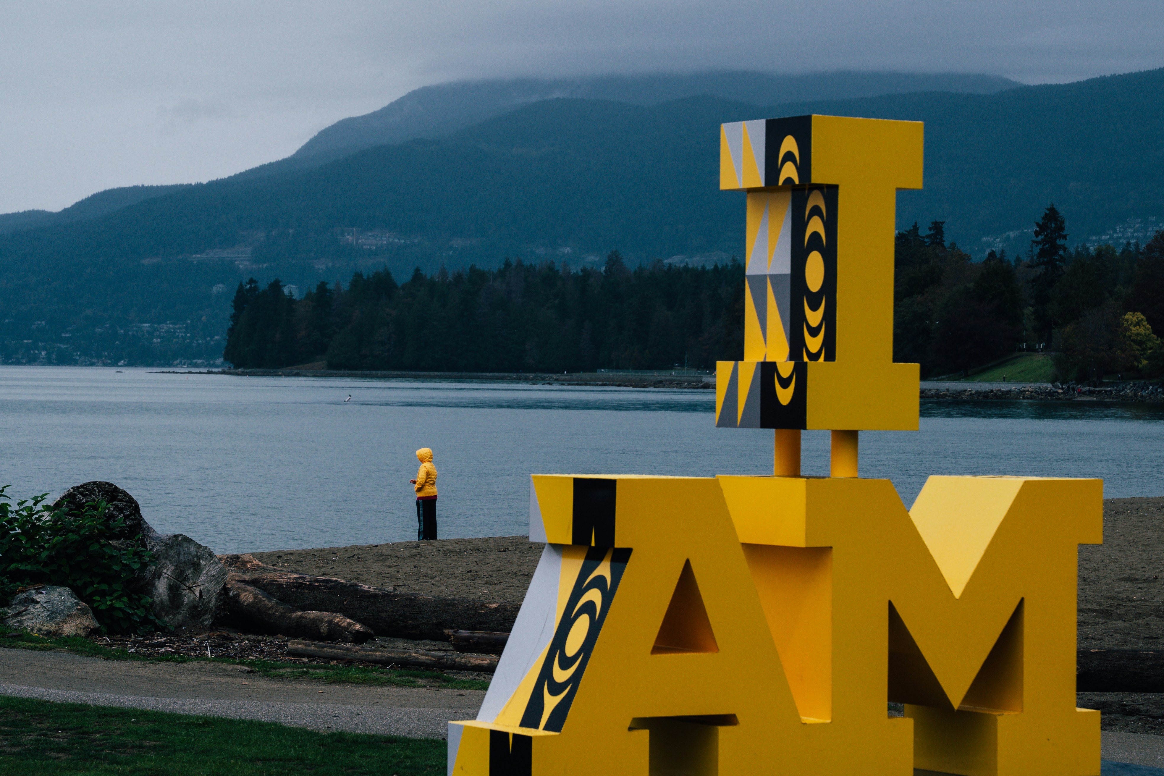 Yellow Art Sculpture by the Shore under Dusky MountainsChun Wang