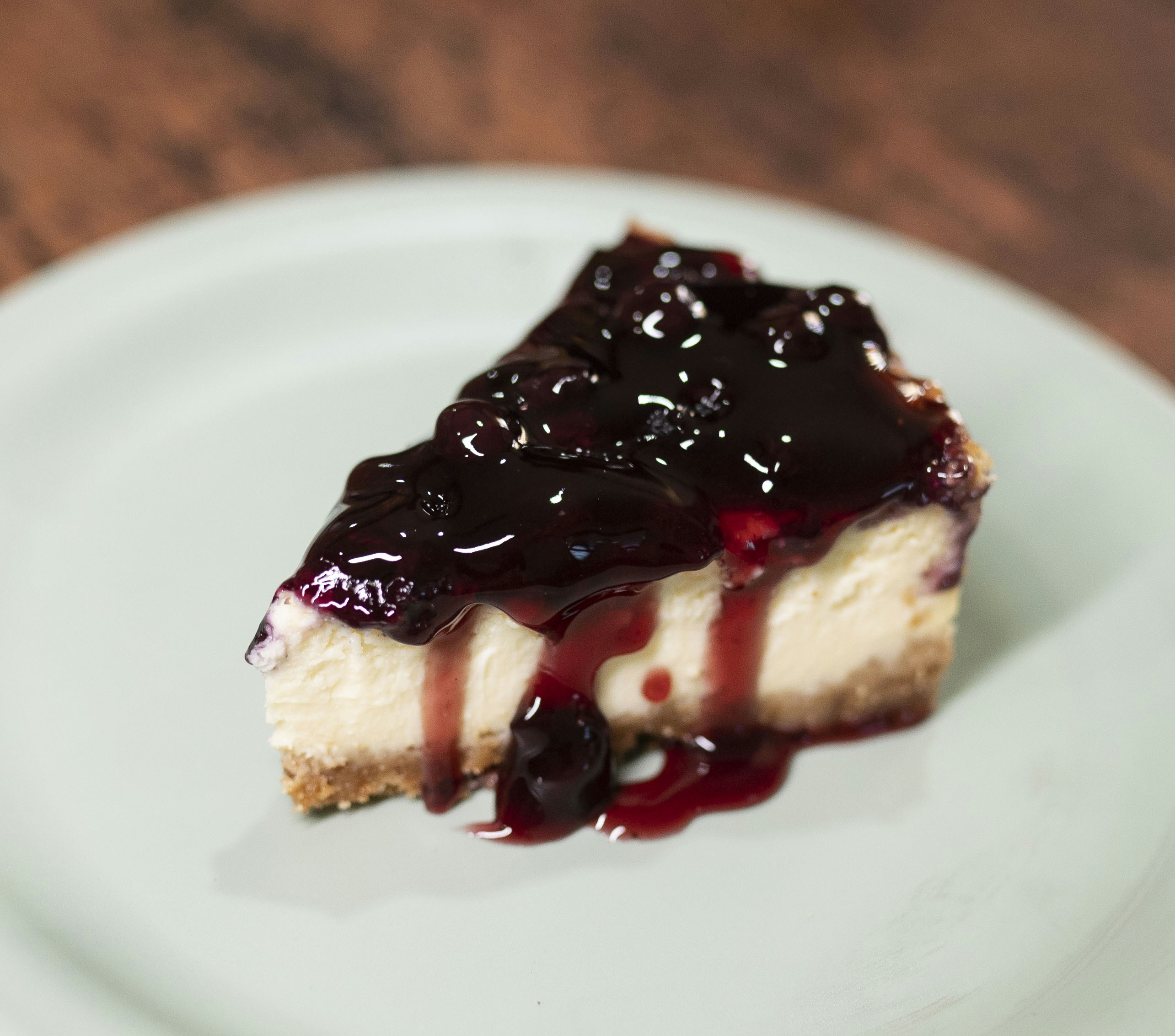 Cherry Silk Cheesecake Slice on a Pale Plate