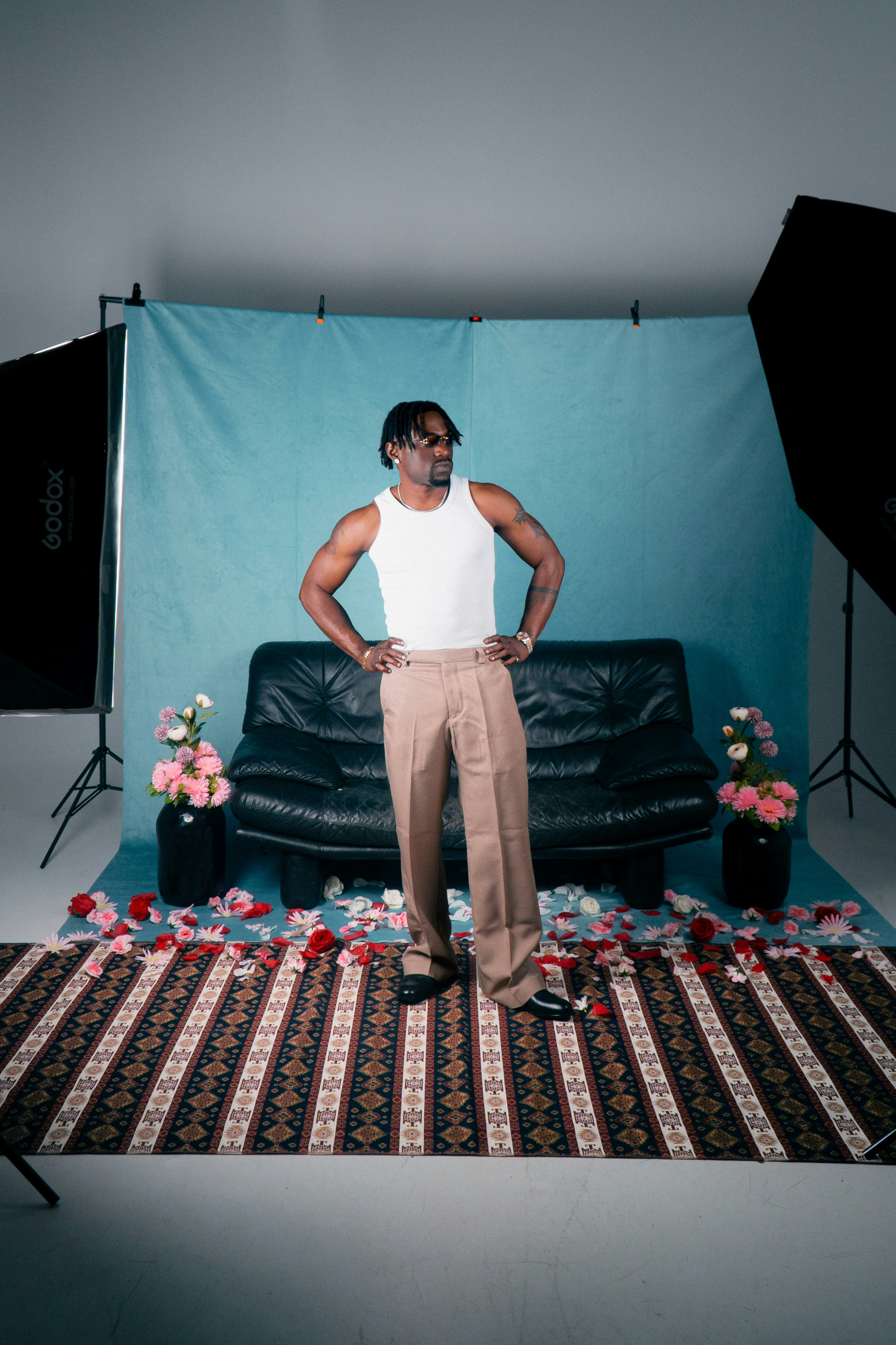 Confident in the Studio: A Bold Portrait Amid Colorful Florals