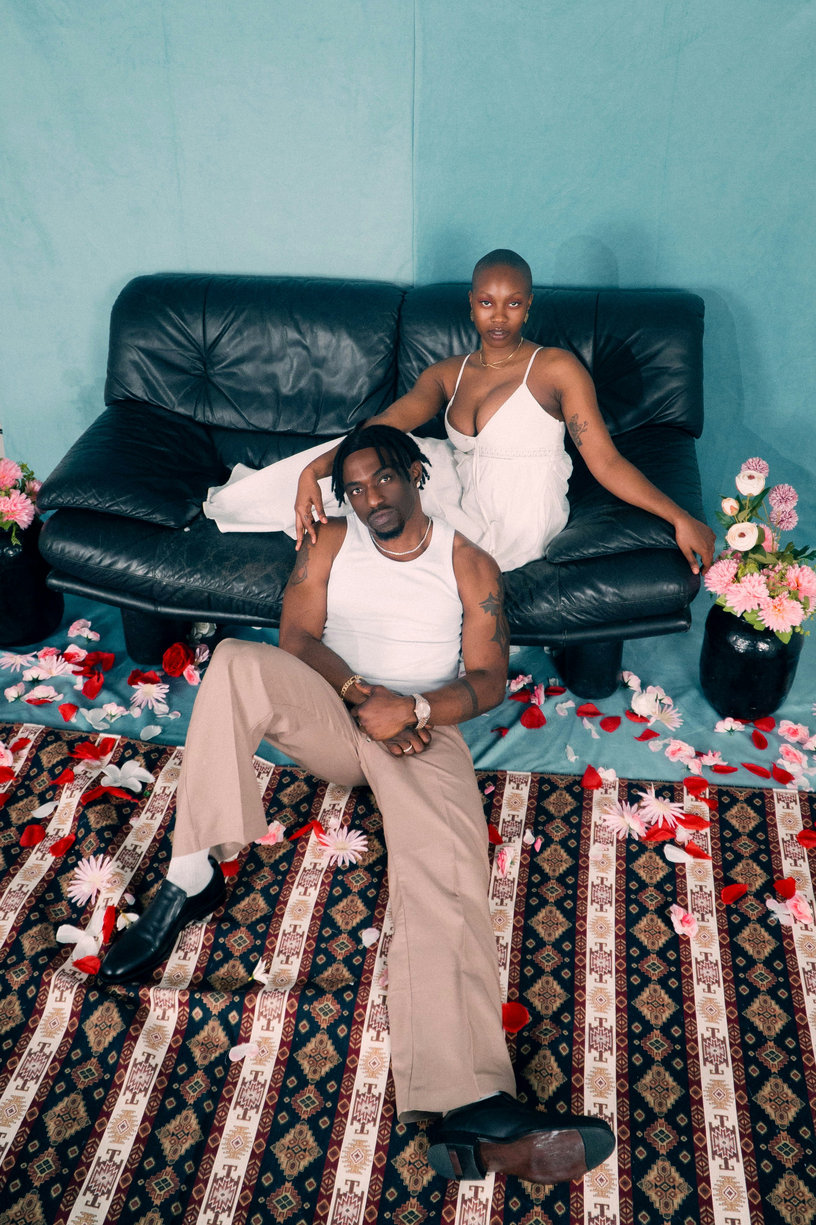 Couple on a velvet couch: petals and pattern beneath