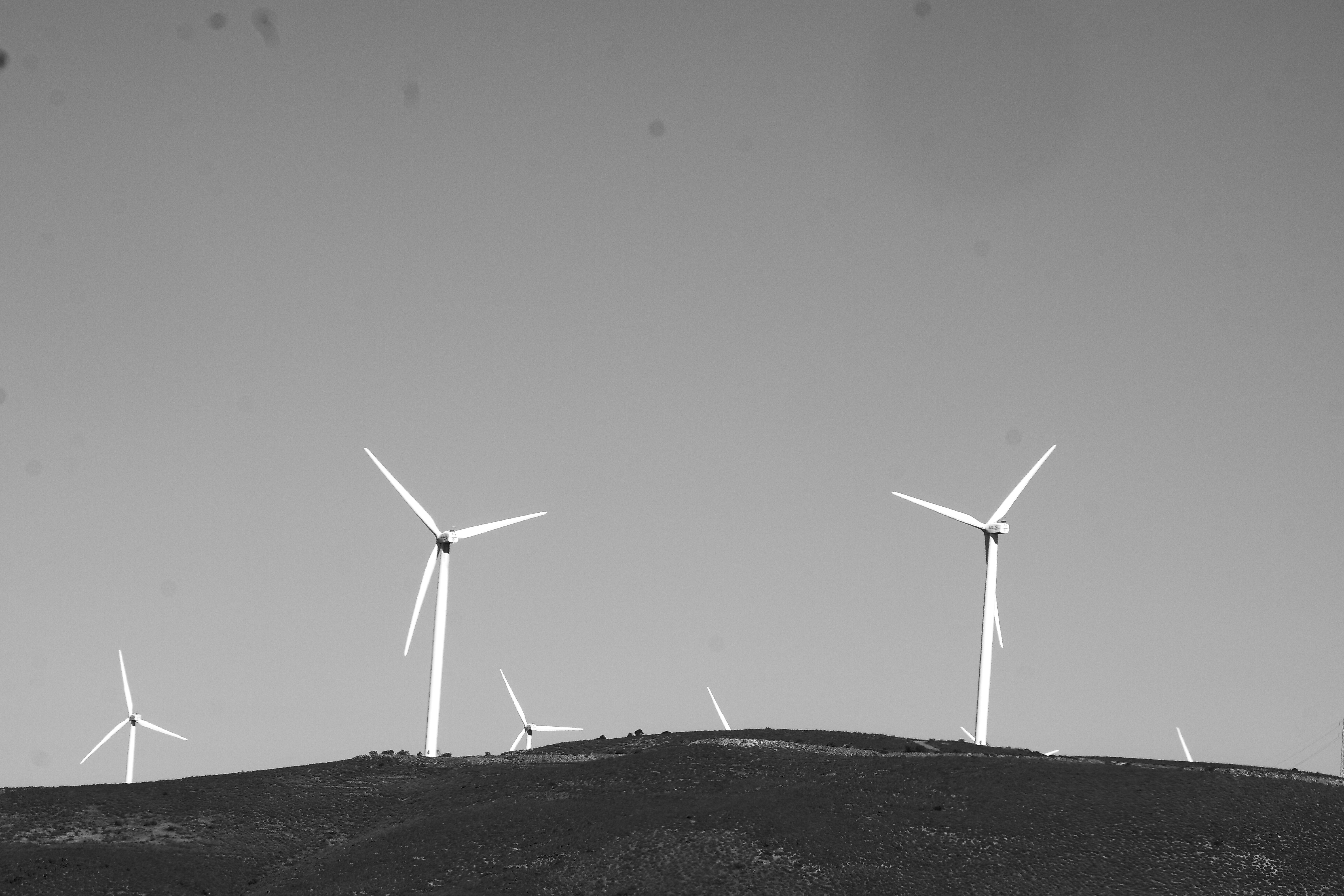Windmills on a Quiet Hill under Wide Open Sky
