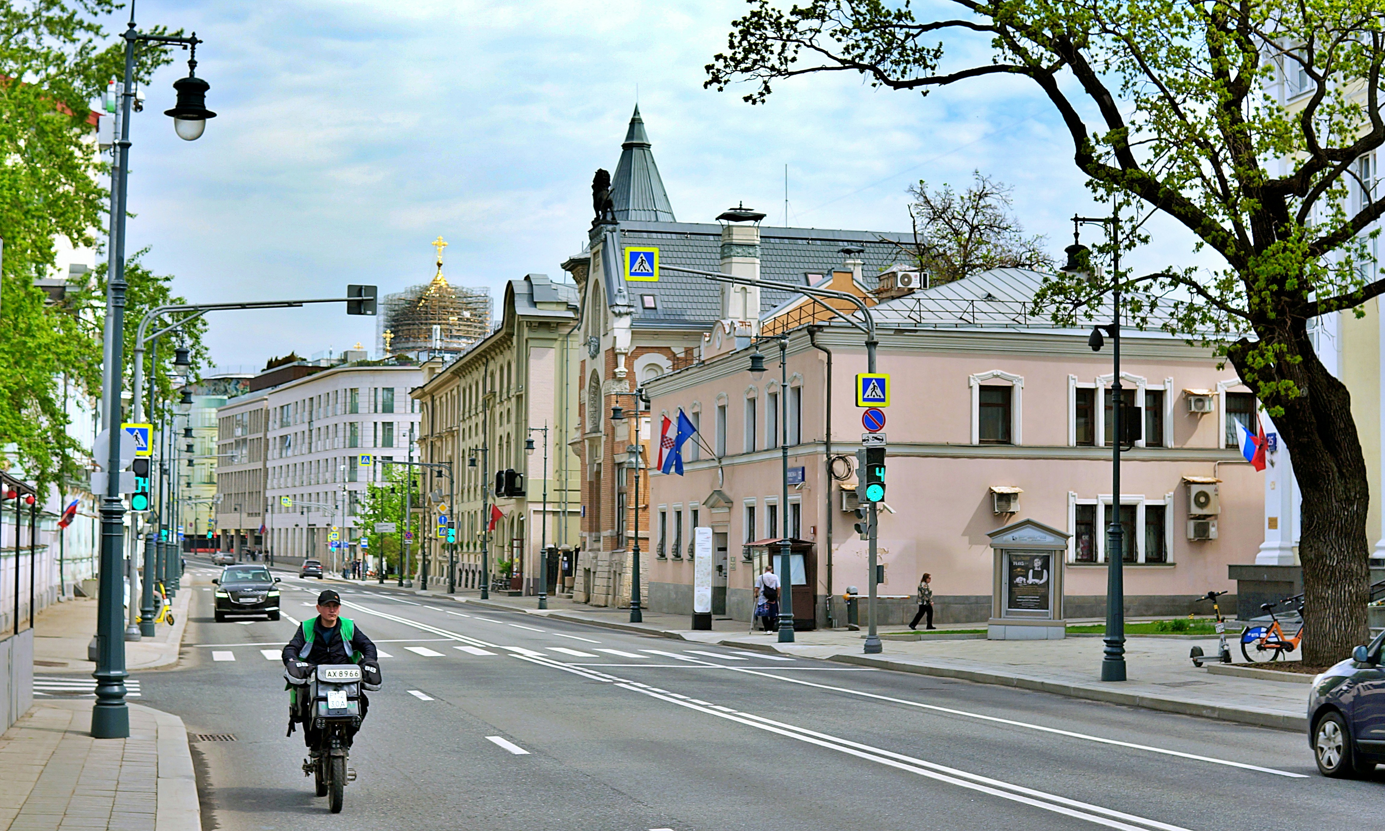 City Street Pulse: A Quiet Motorbike Rides Through Classical Facades