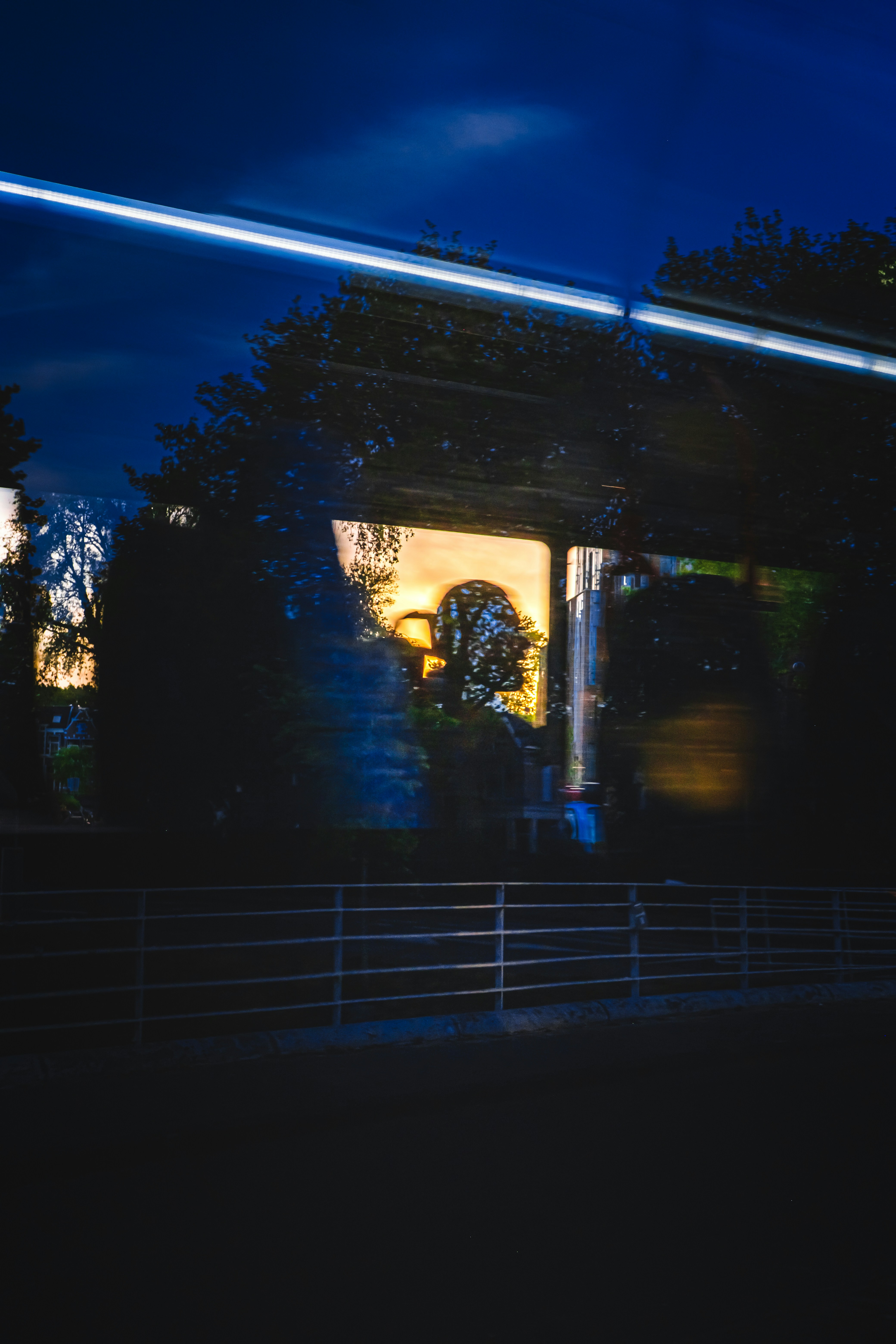 Velvet Night Reflections Through a Transit Window