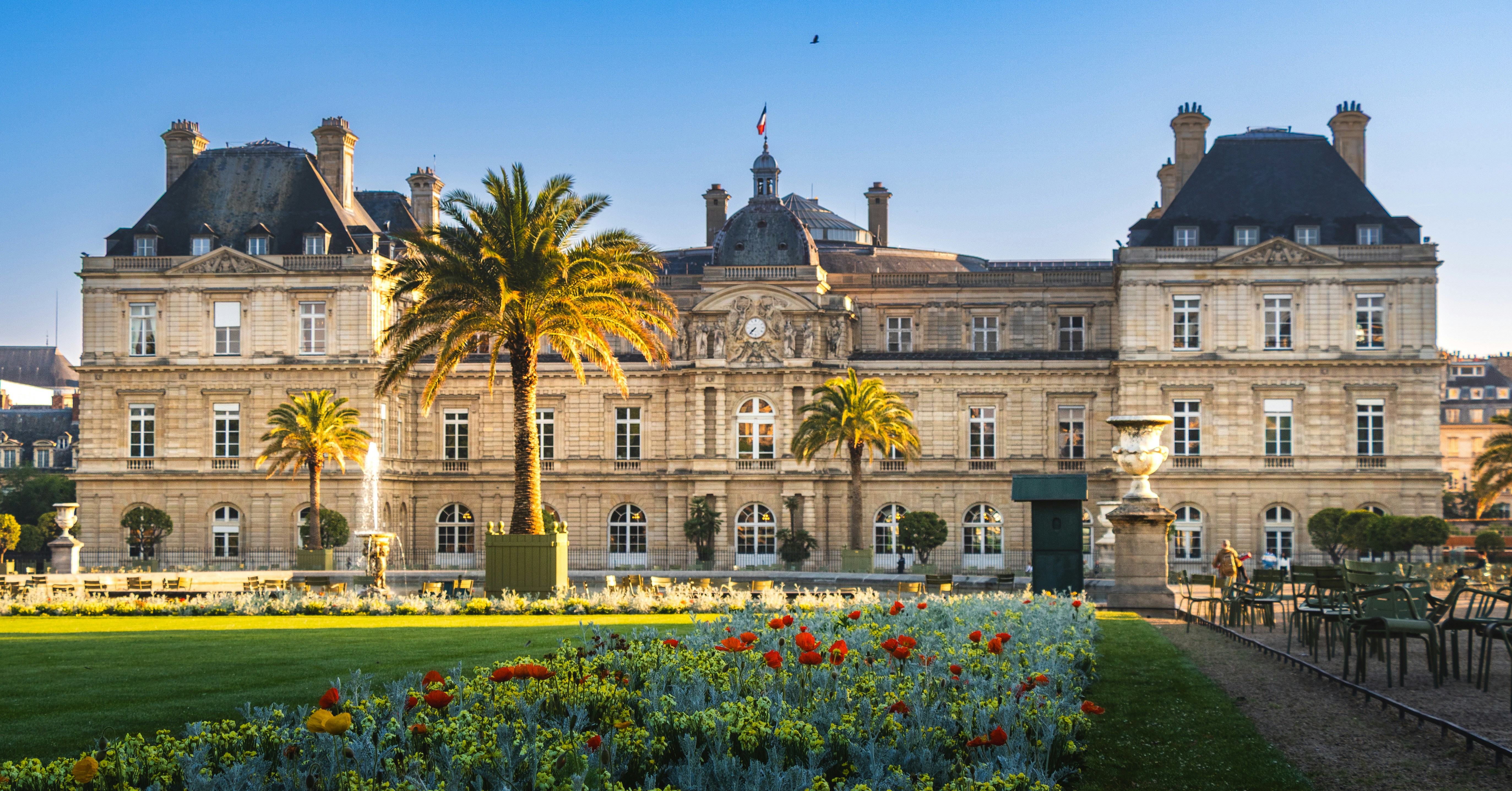 Symmetrical Belle Époque Facade Framed by Fragrant Gardens