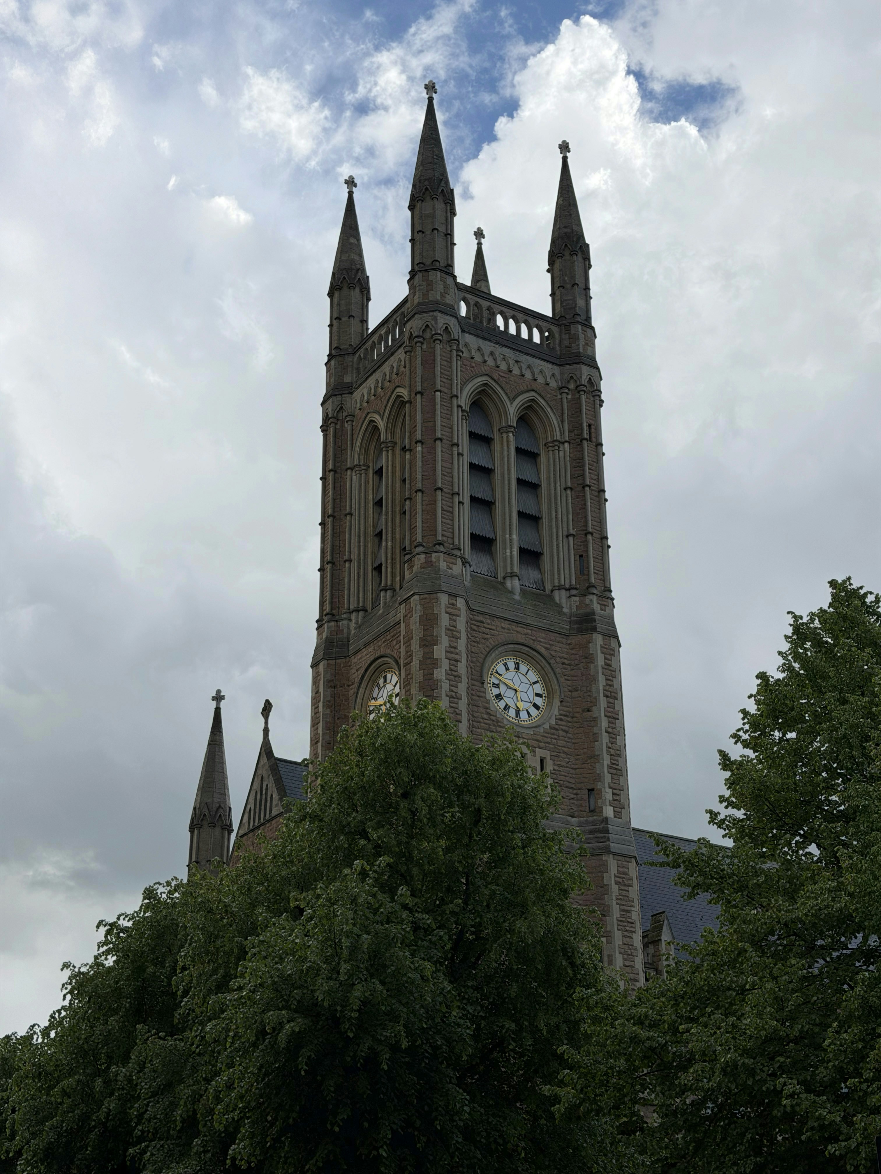 Gothic Clock Tower Reaching Toward a Sky of Clouds