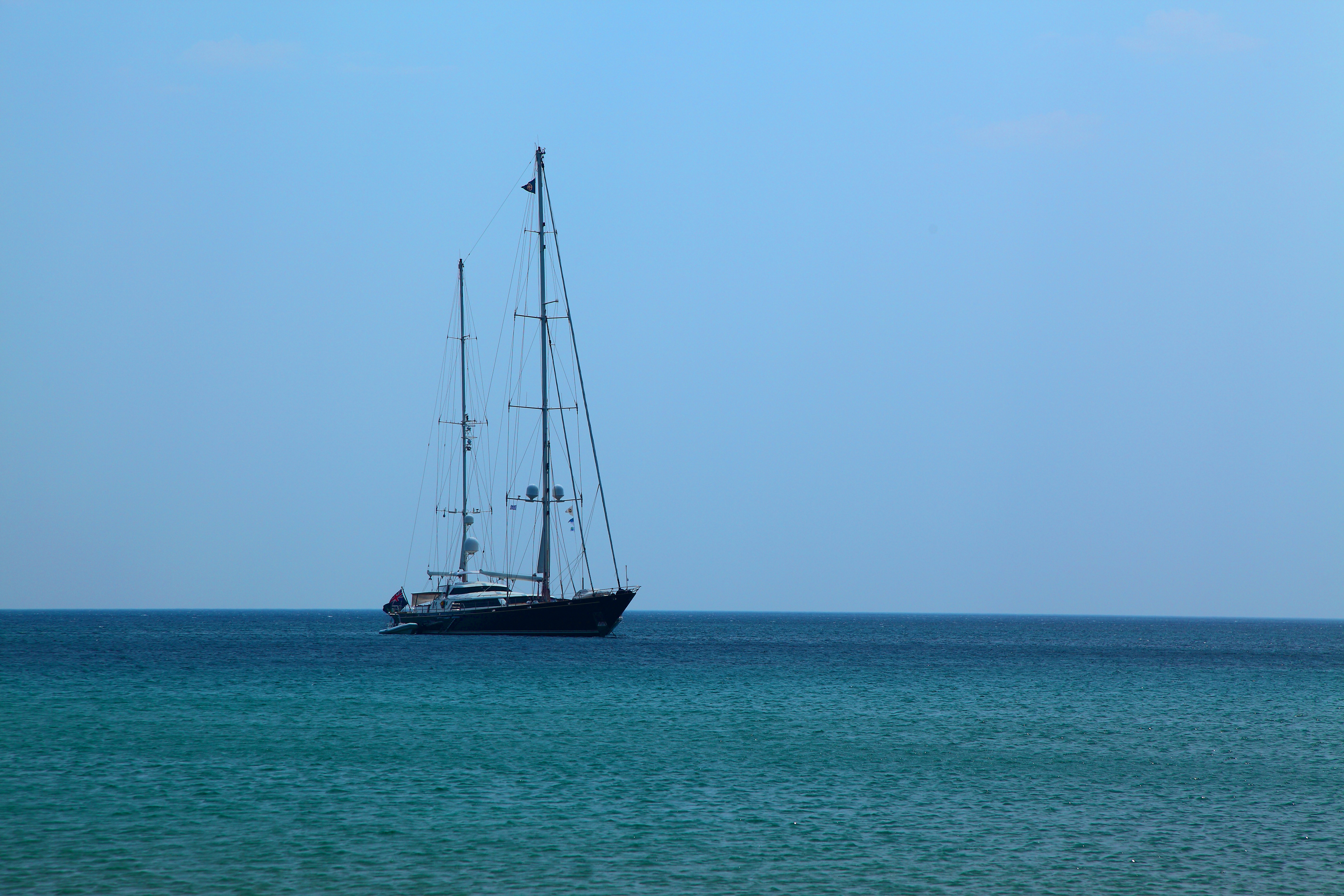 Sailing Solitude: A Lone Yacht Resting on Calming Seas