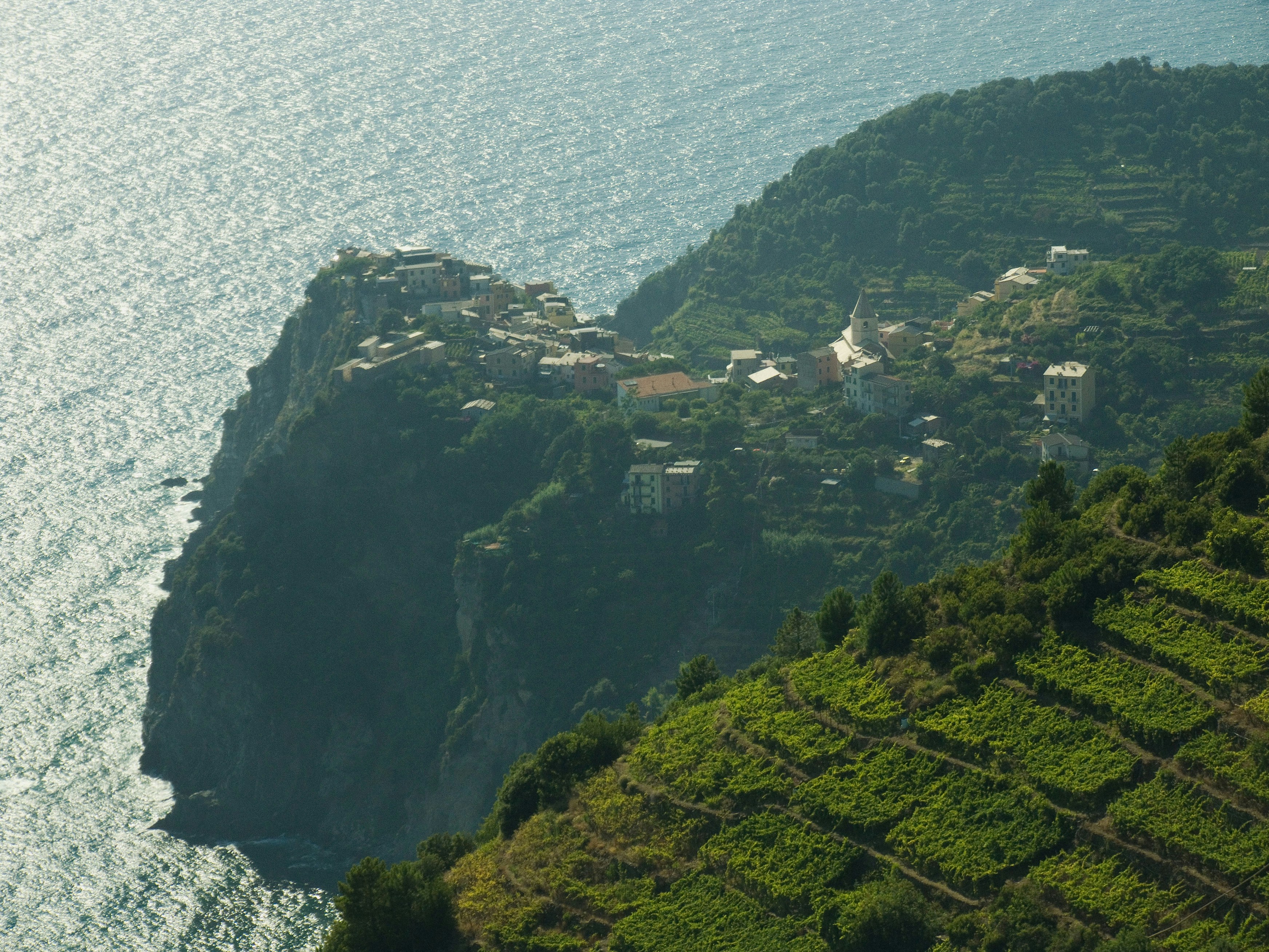 Clifftop Village Quietly Adheres to the Sunlit Verge