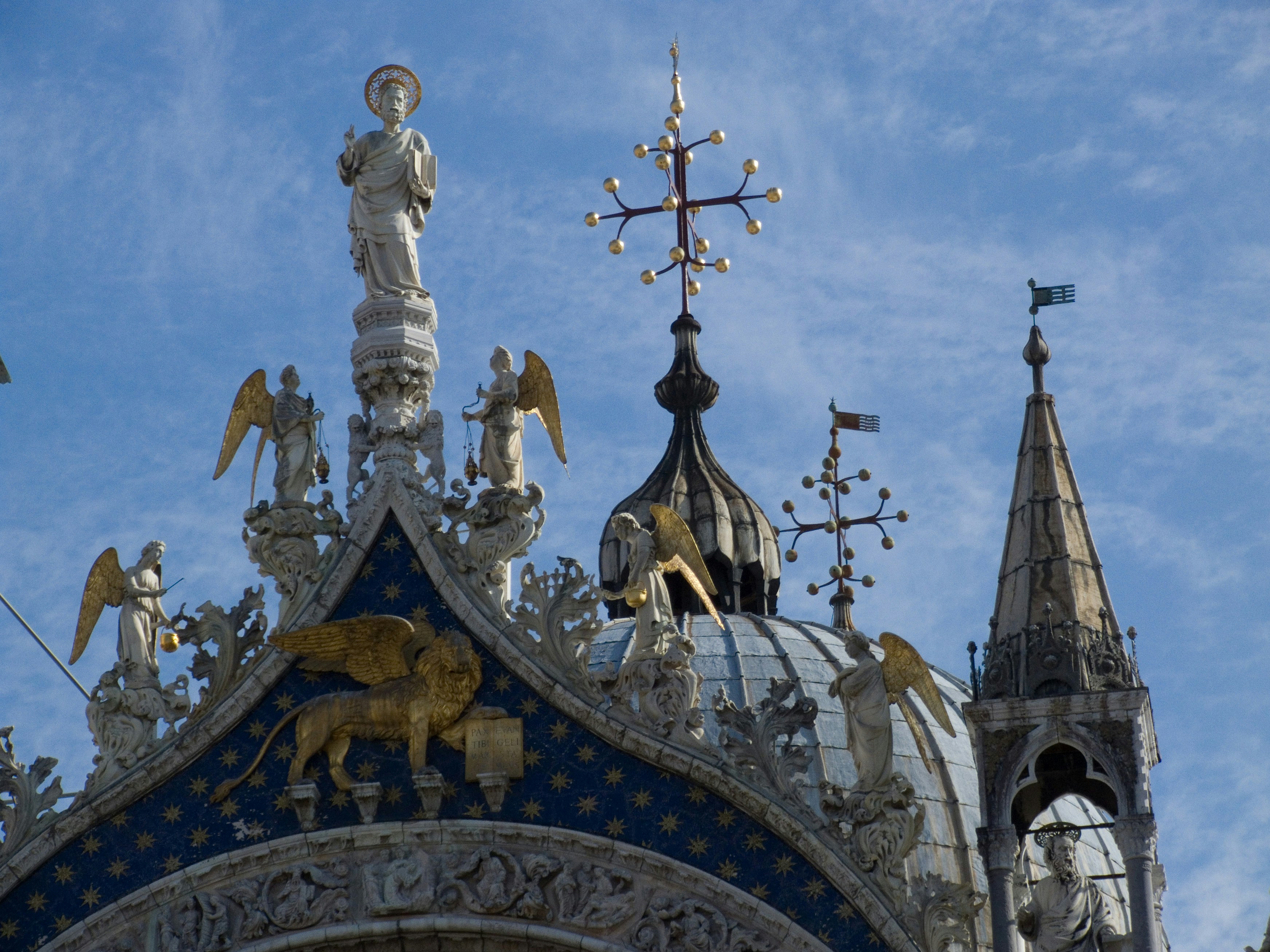 Gilded Spires and Sculpted Guardians Above the Blue Sky