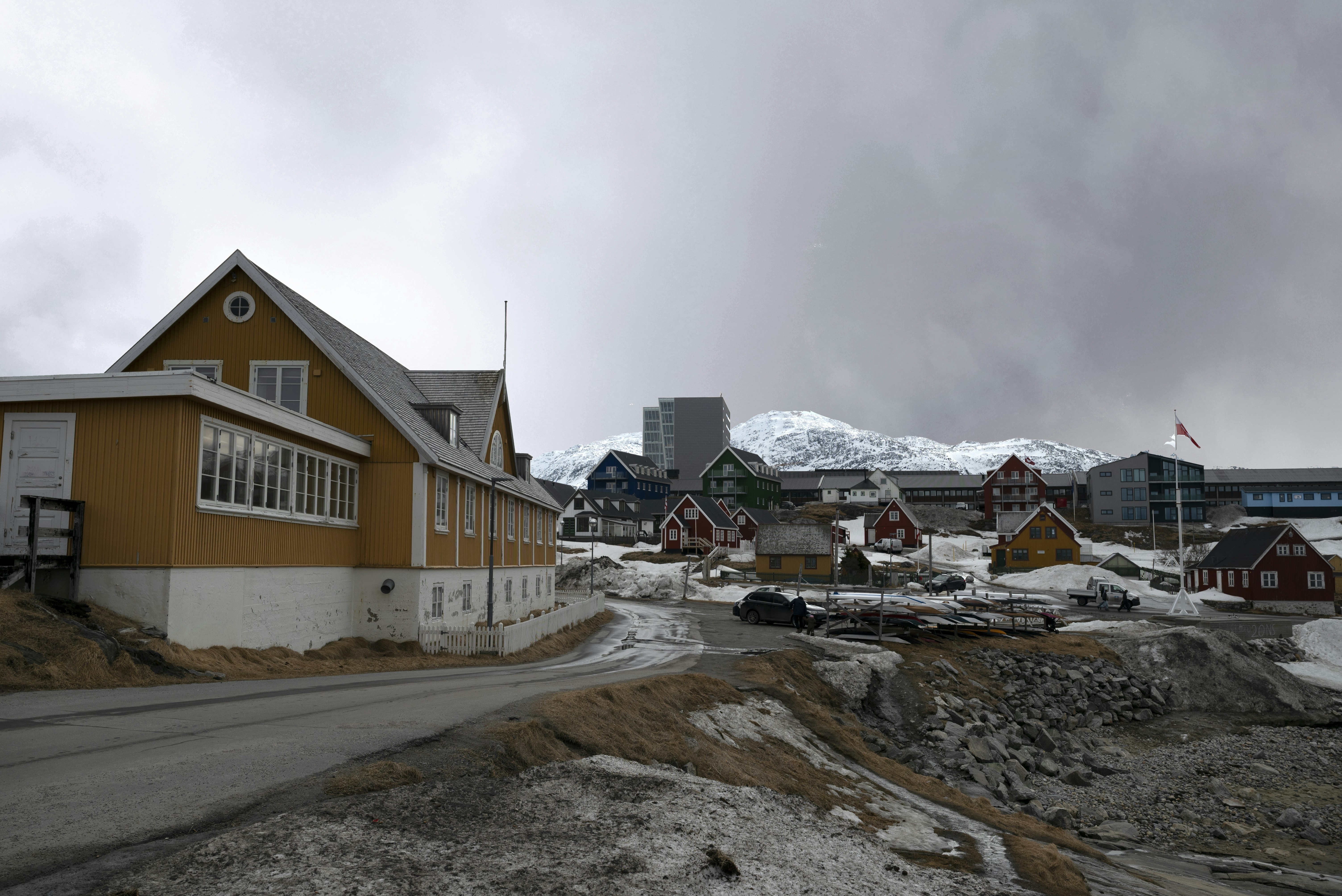Snowy Harbor Village Under a Stormy Sky
