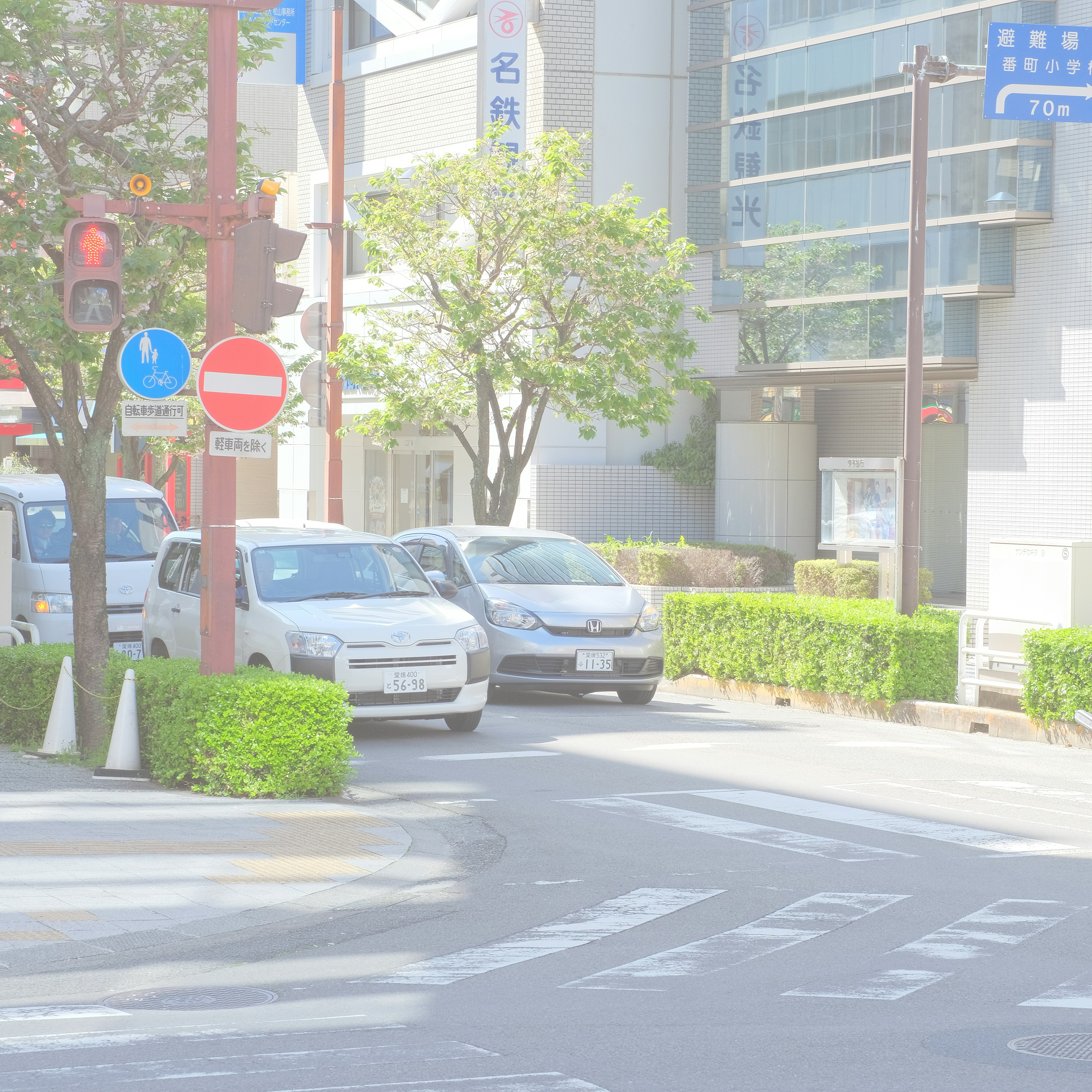 Sunlit Street Corner with Modern Architecture and Car Lineup