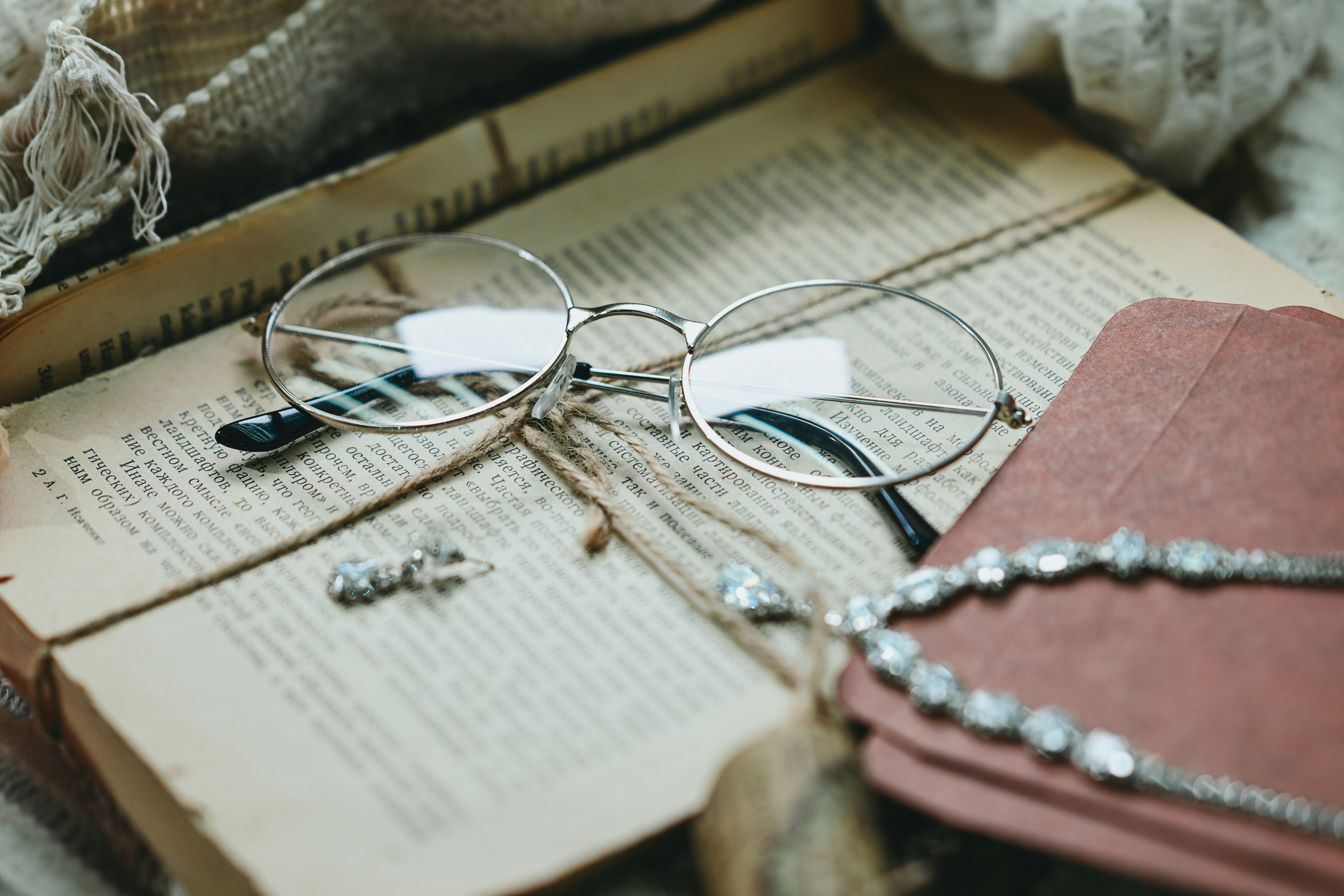 Glasses Resting Between Pages: Quiet Study of Timeworn Texts
