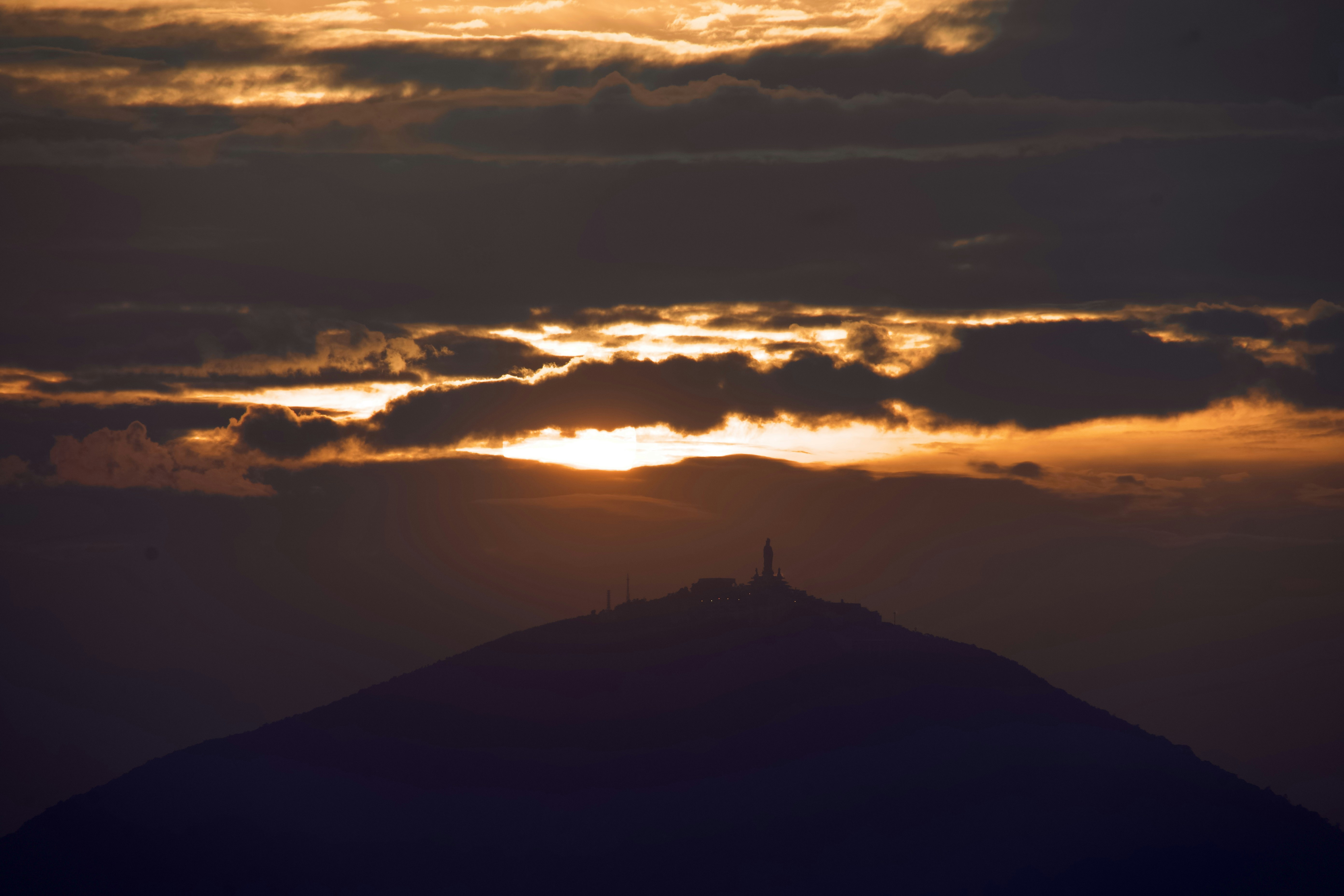 Silhouette at Dusk: The Summit Against a Burnt Sky