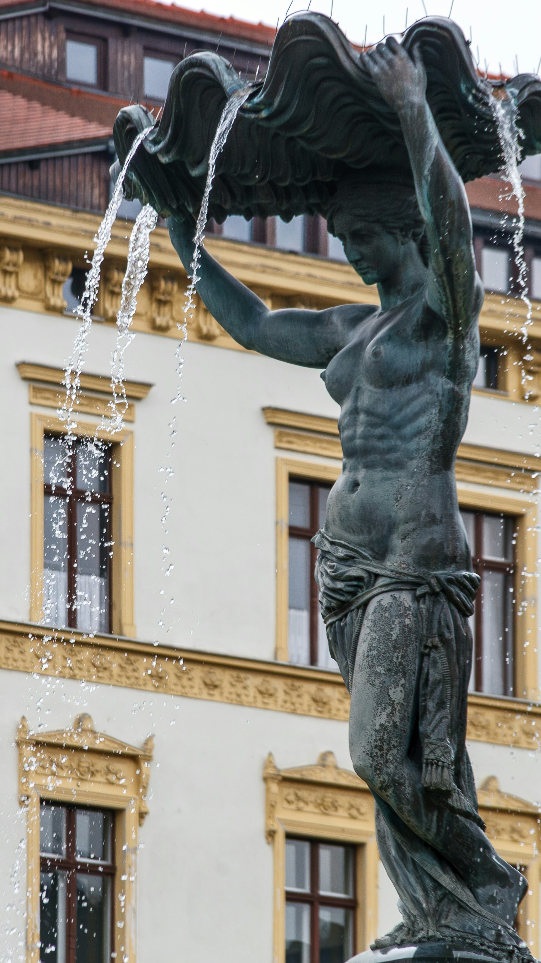 Winged Fountain Guardian: A Scripted Pose of Strength and Water