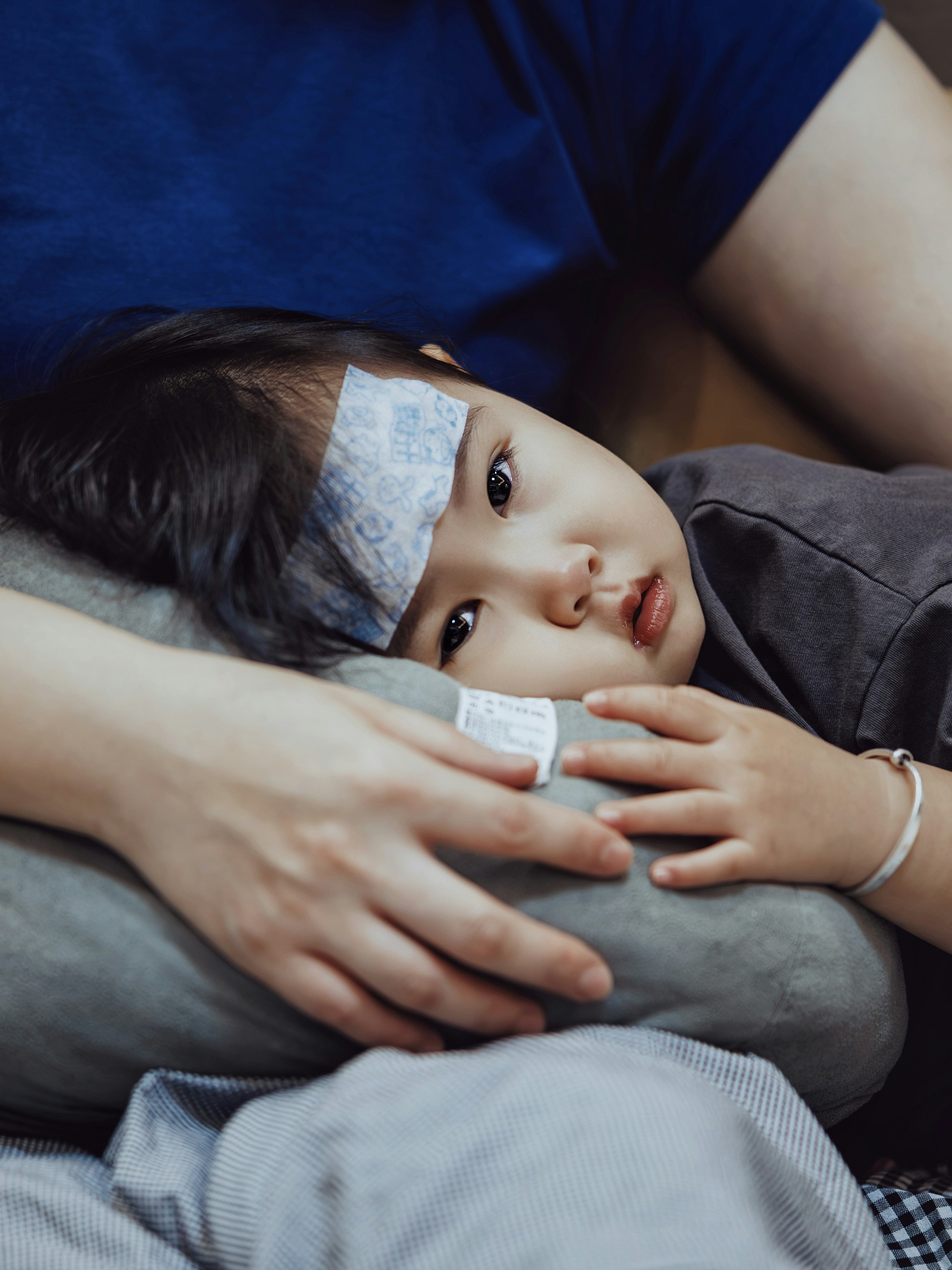 Soothing Embrace: A Child's Quiet Rest Among Loving Hands