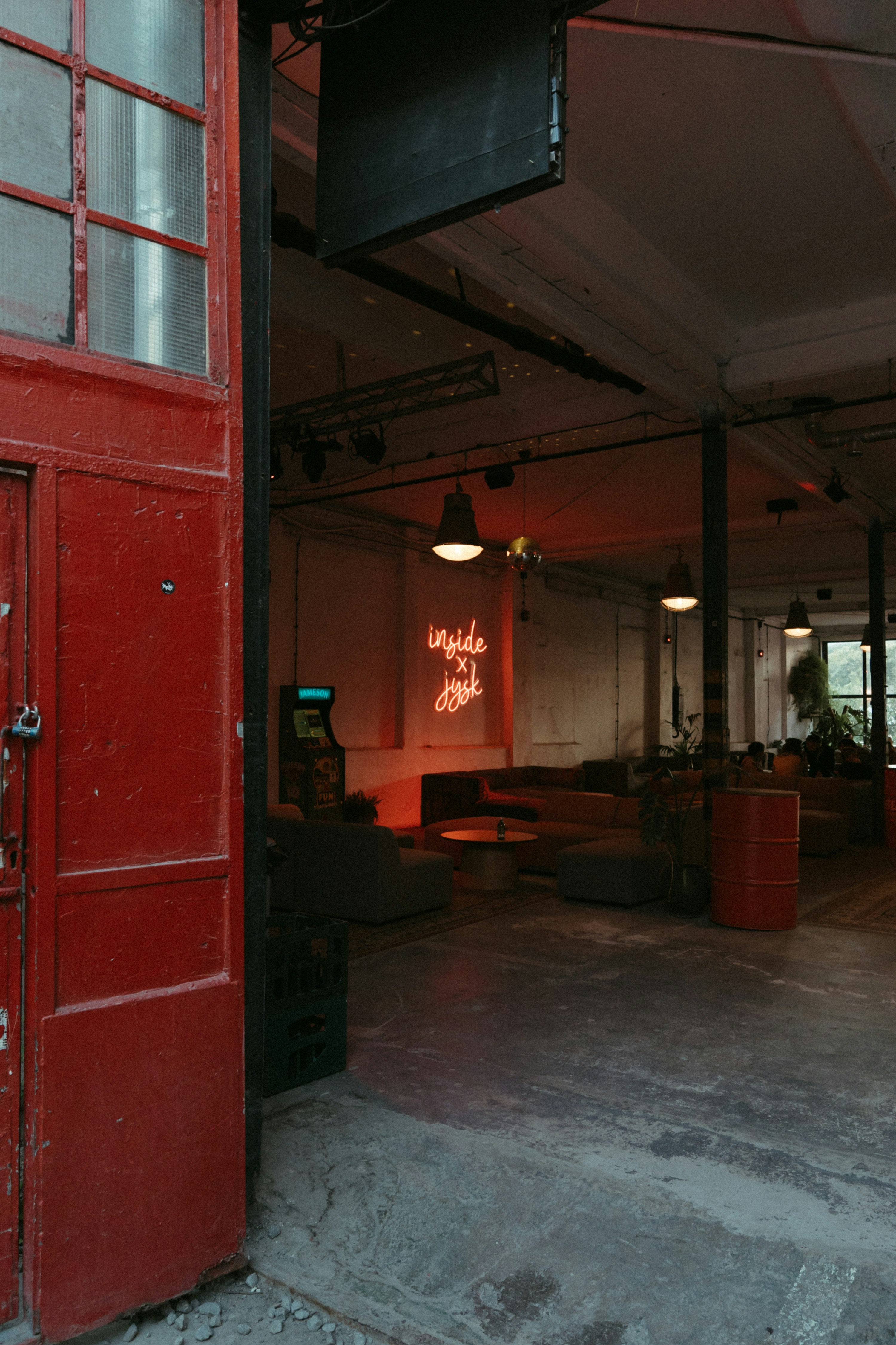 Red Doorway into a Neon-Lit Lounge Haven