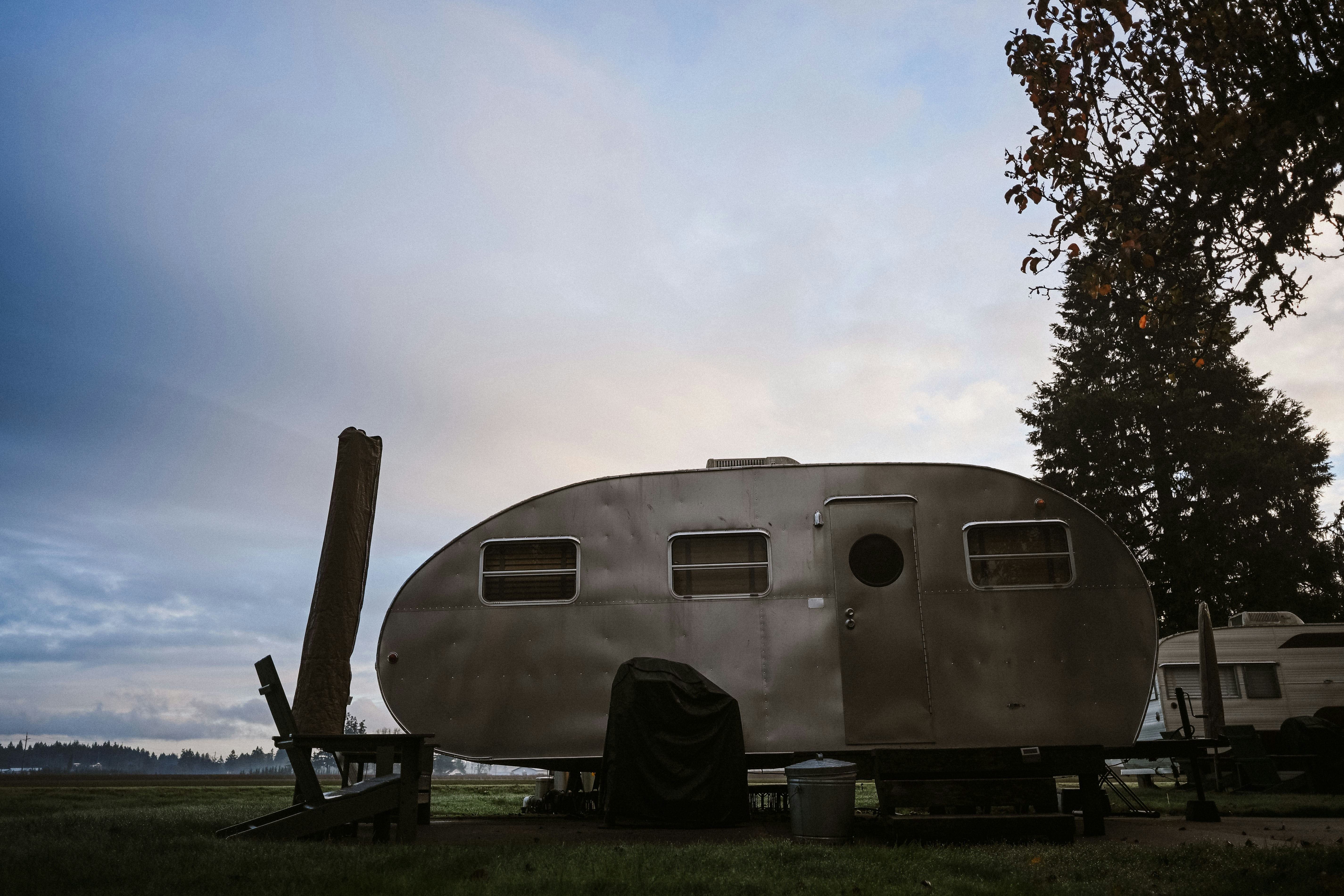 A Silver A-frame Camper Resting Under Evening Sky