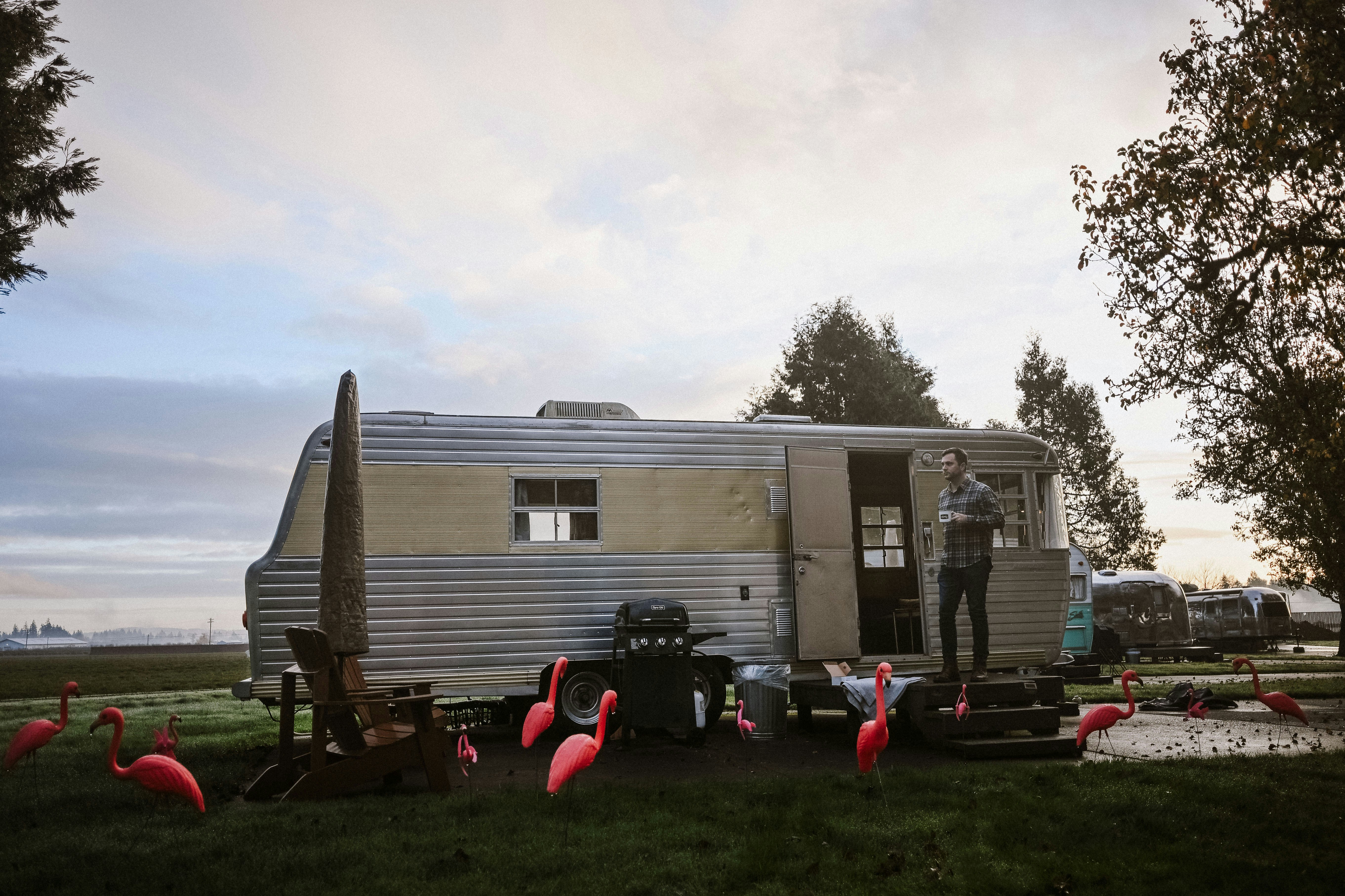 Deserted RV, Surrounded by Plastic Flamingos and Sunset Light
