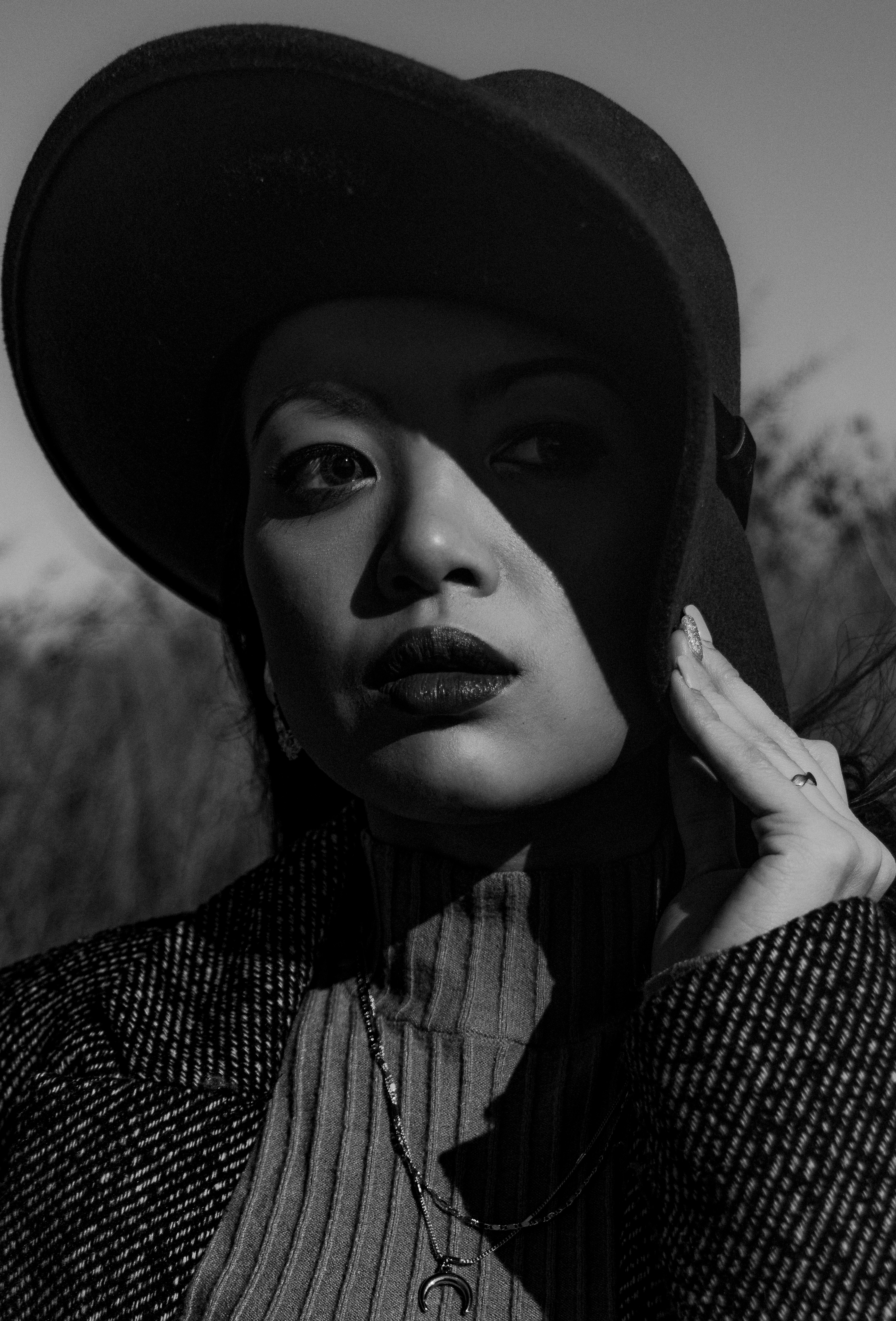 Shadowed Grace in a Wide-Brim Moment