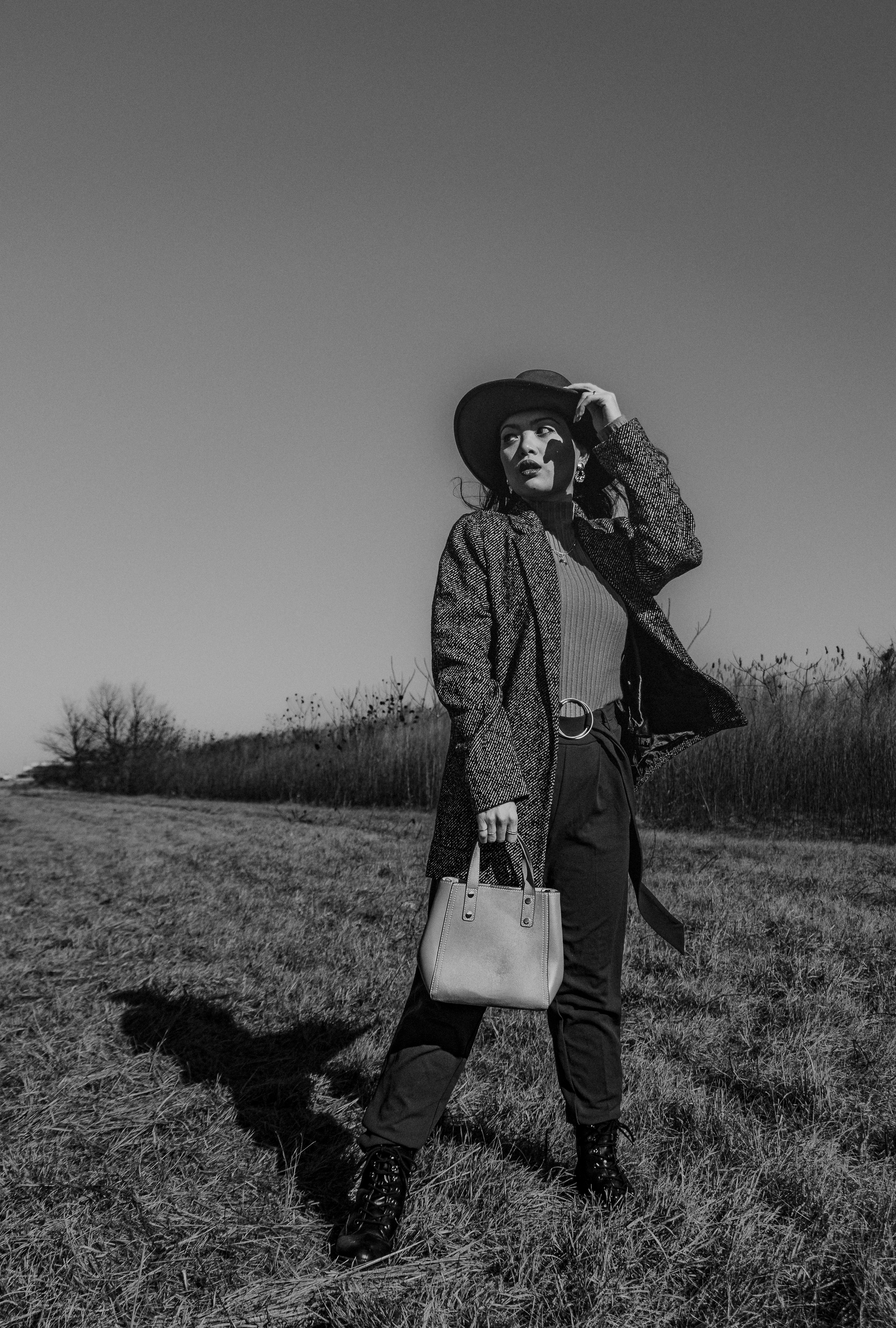 Wind-kissed Portrait in Monochrome: A Woman in a Wide Field