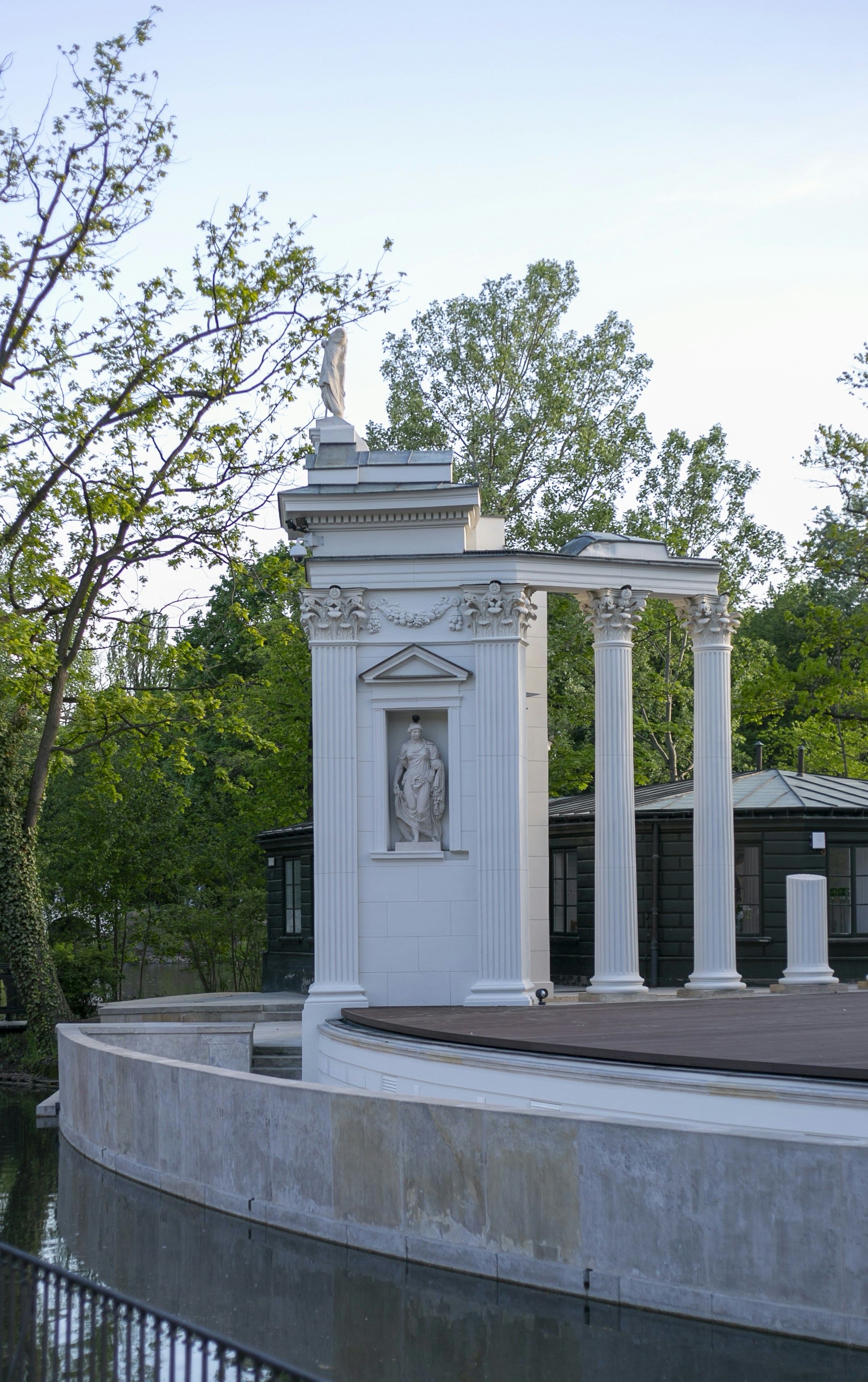 Classical Fascade: A Statue framed by Grecian Columns at Dusk