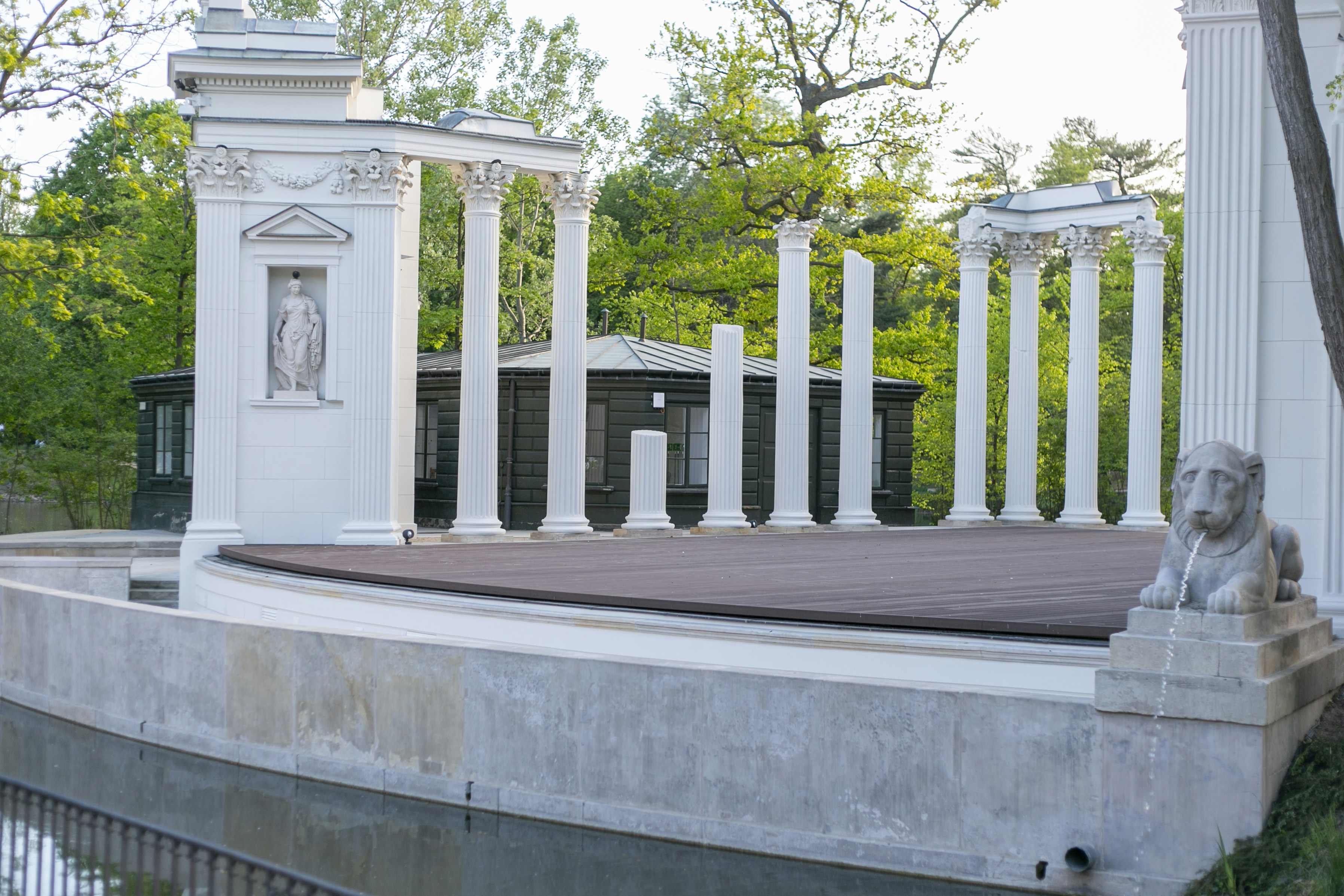 White-pillared amphitheater framing a serene hawk-eyed garden