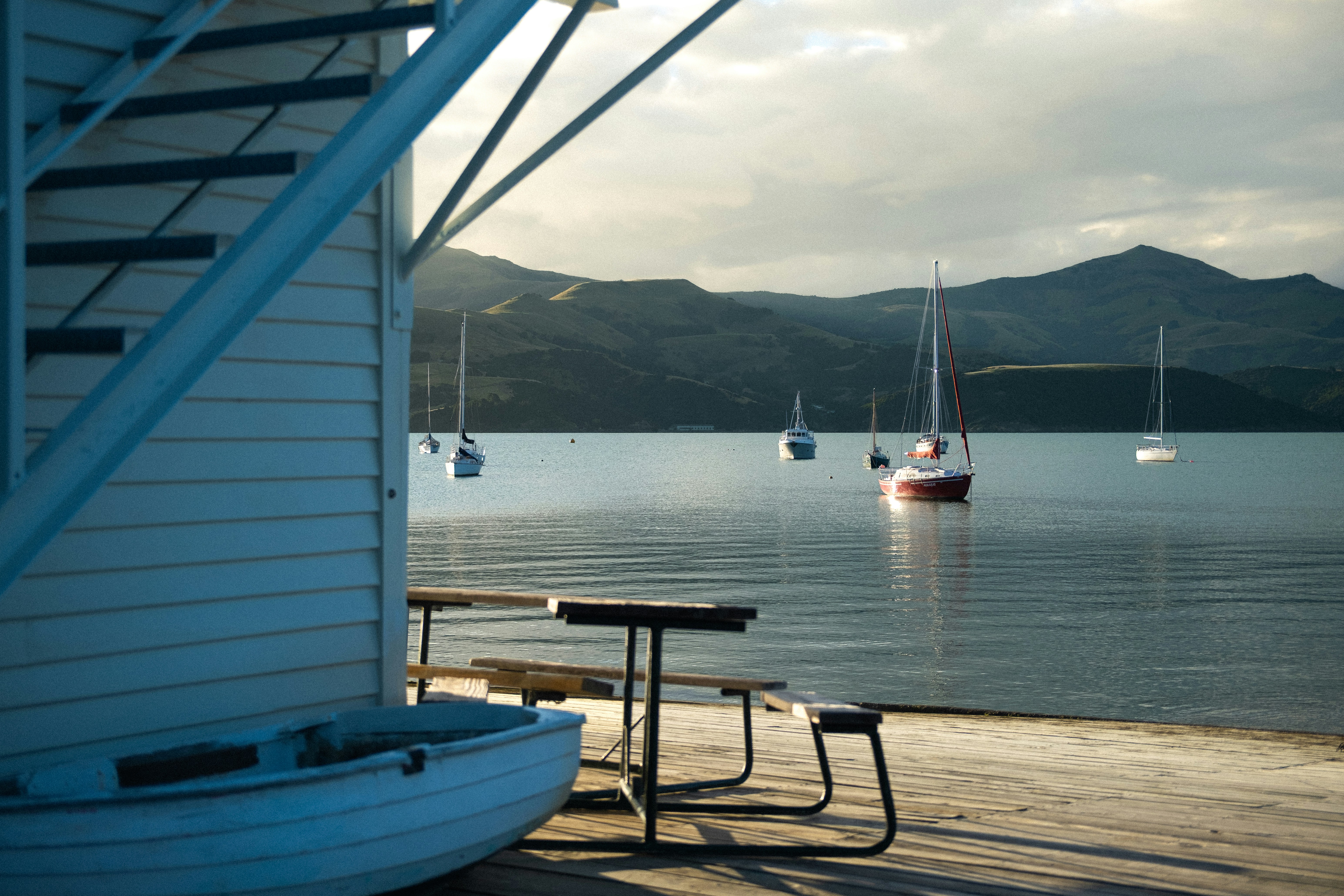 Harbor Quiet: Boats at Rest Behind a Painted Pier