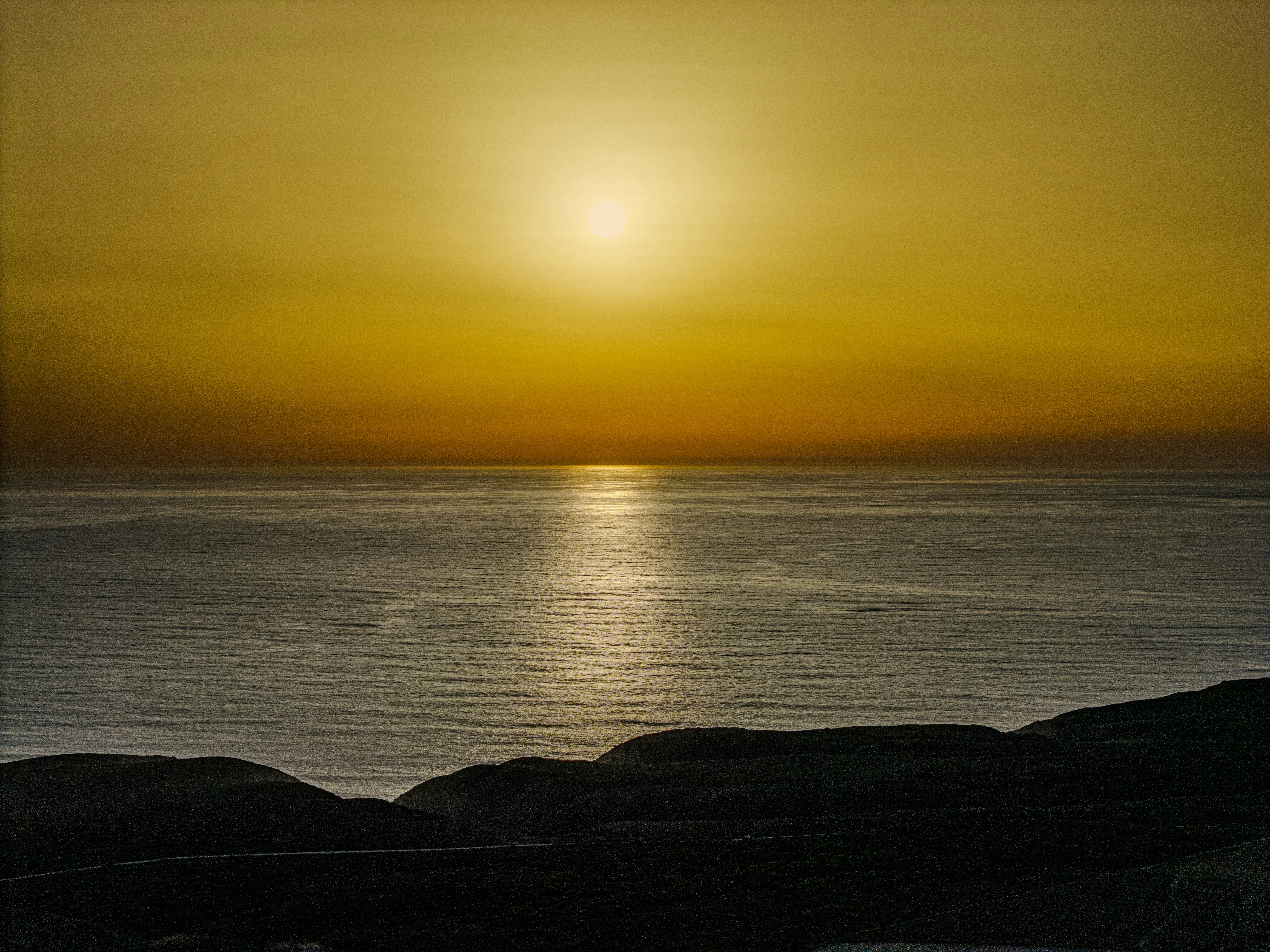 A vibrant golden sunset over a peaceful ocean.
