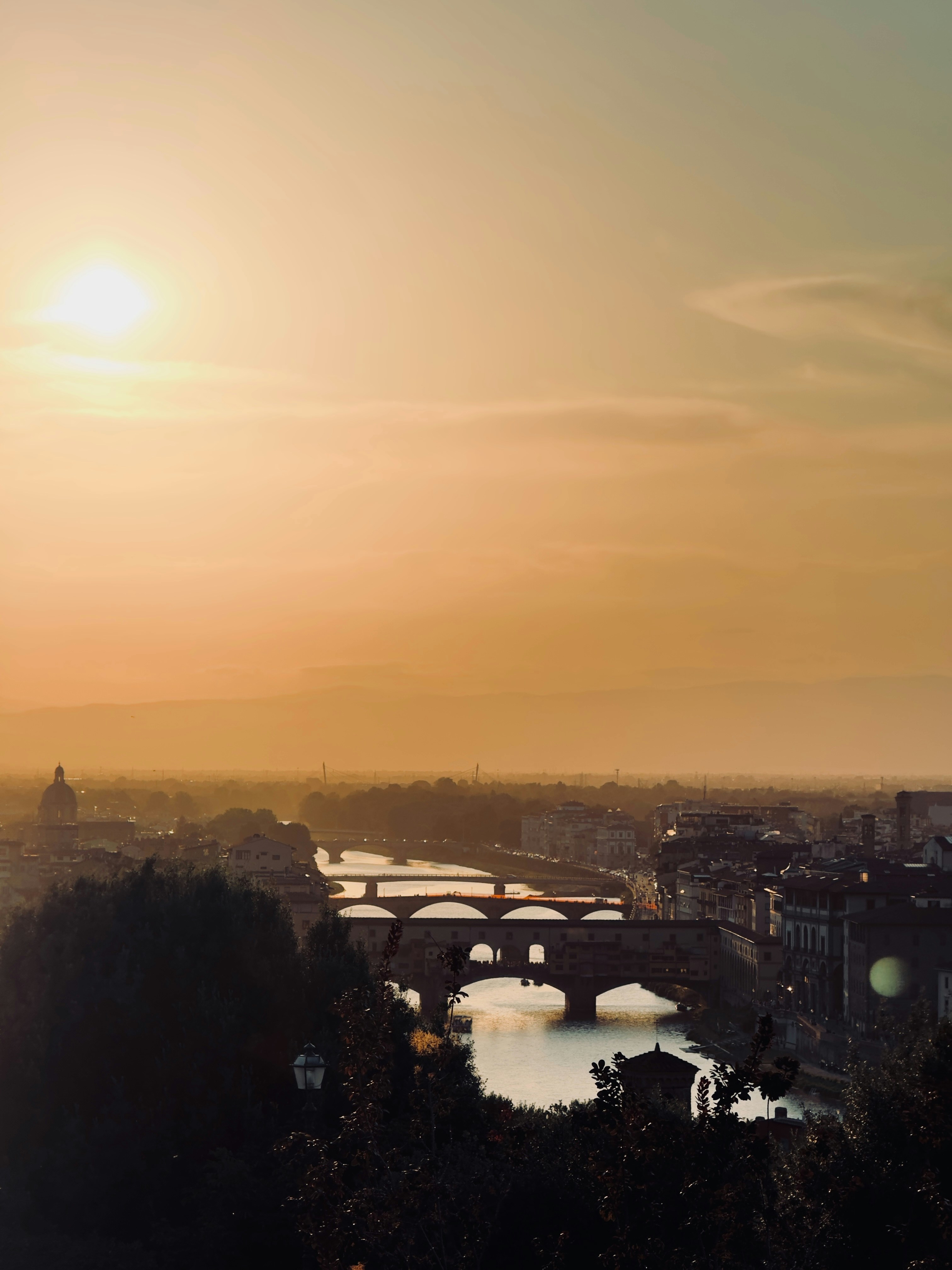 Golden Hour Over the Arched River: A City Quiet Under Warm Skies